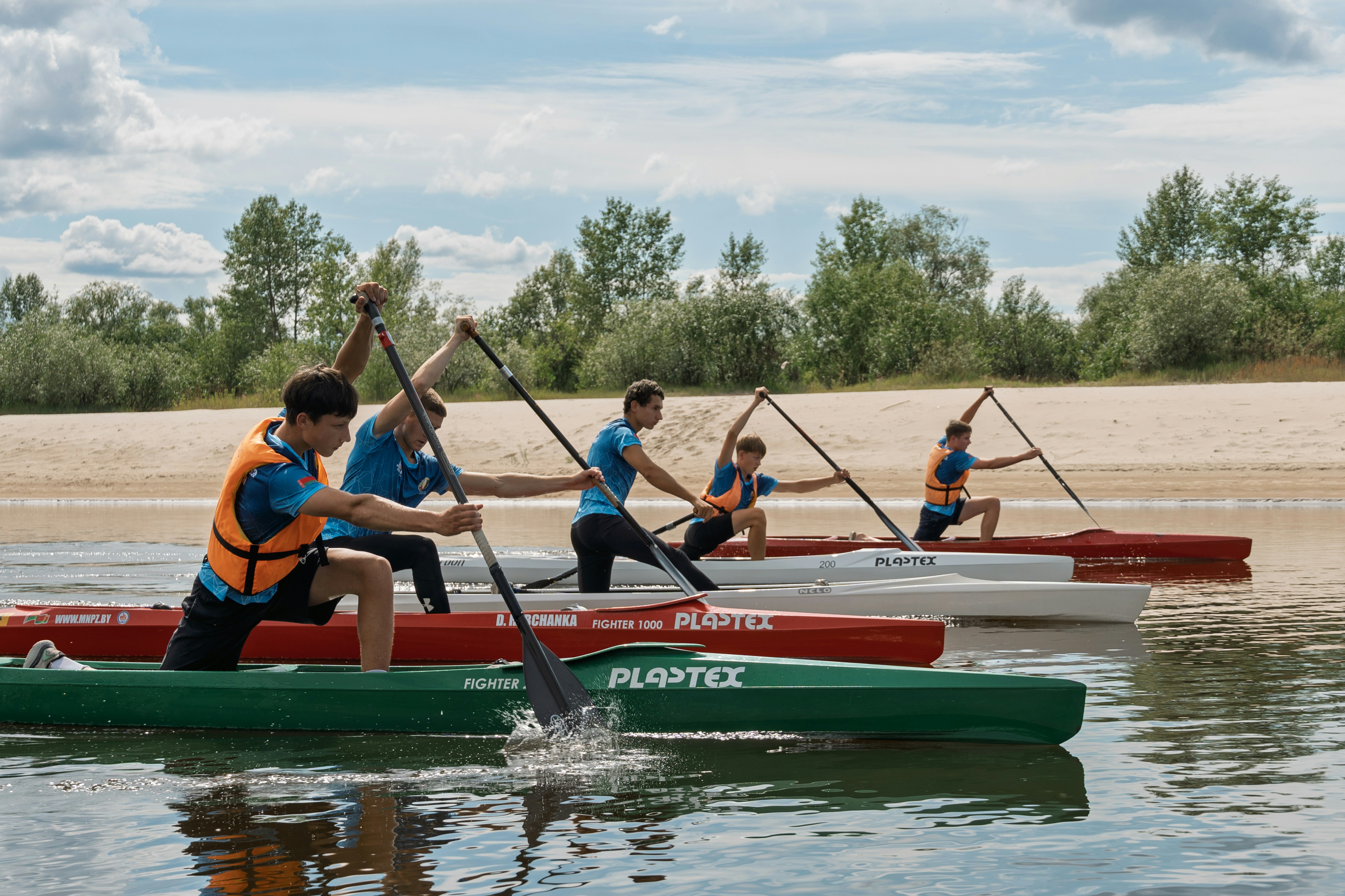 Rowing Toward the Horizon: A Parade of Kayaks on Still Water