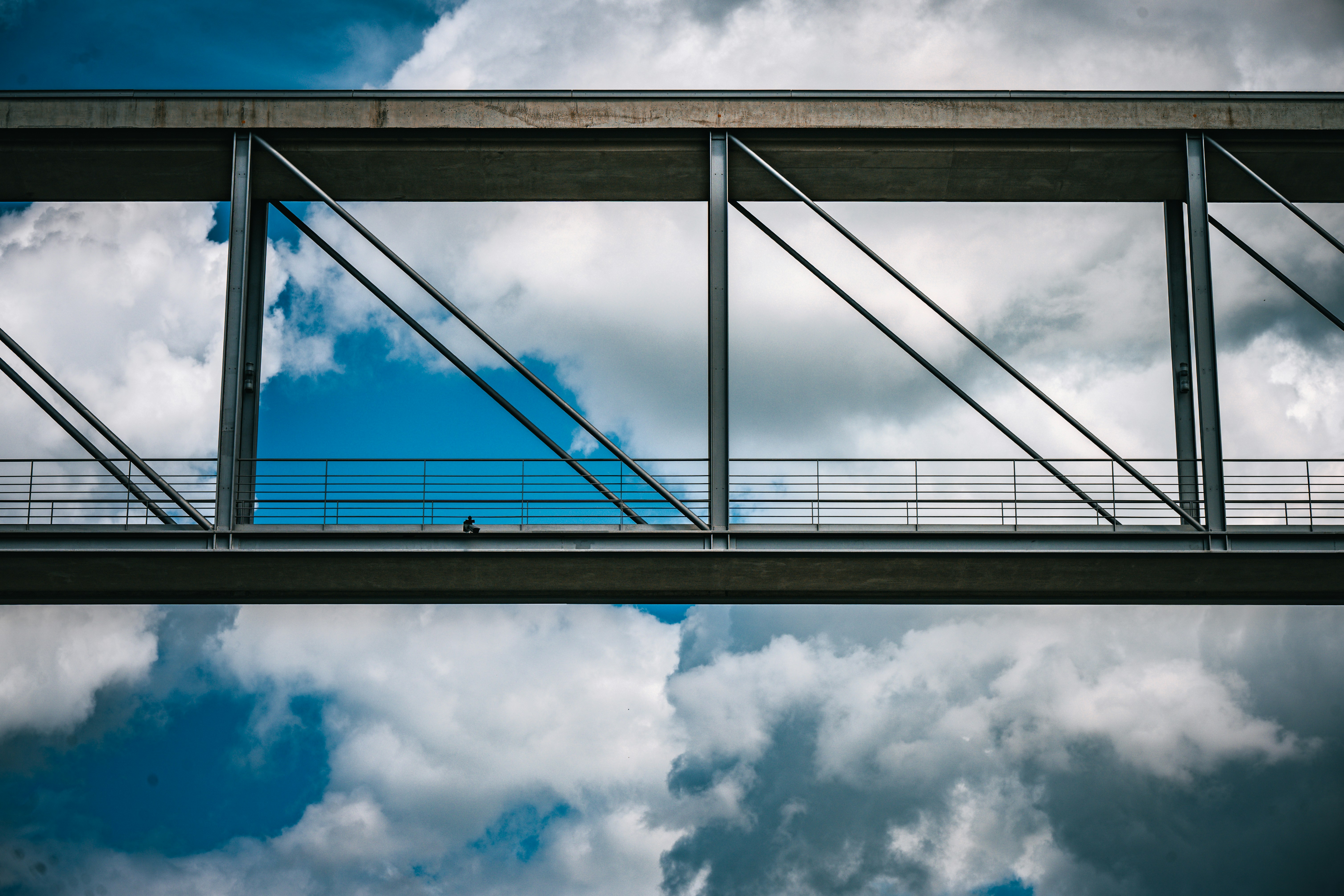 Steel Ribbon Across the Sky: A Minimal Bridge Framing the Clouds