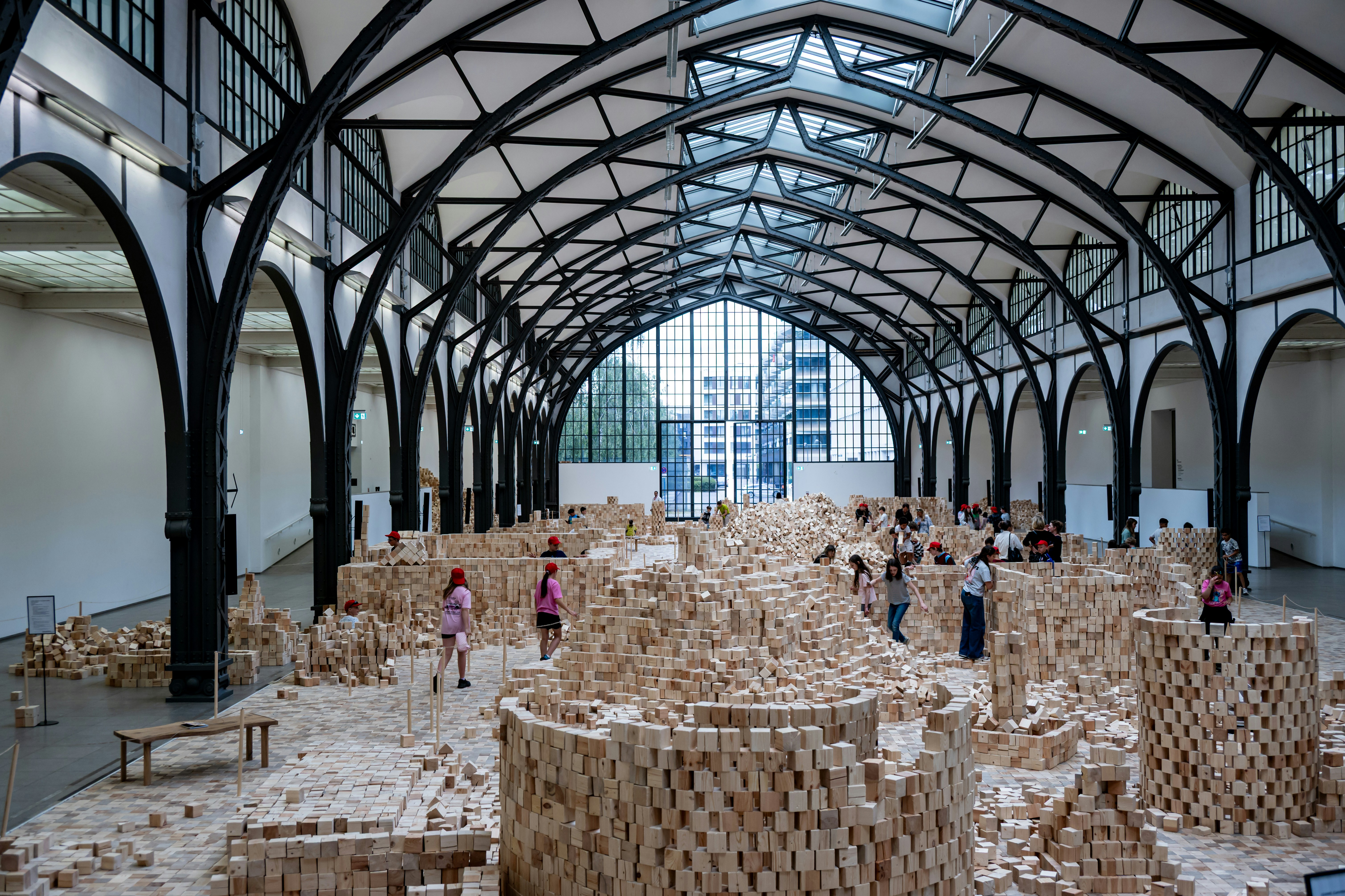 Timber Cathedral: A Field of Wooden Towers Inside a Gleaming Atrium