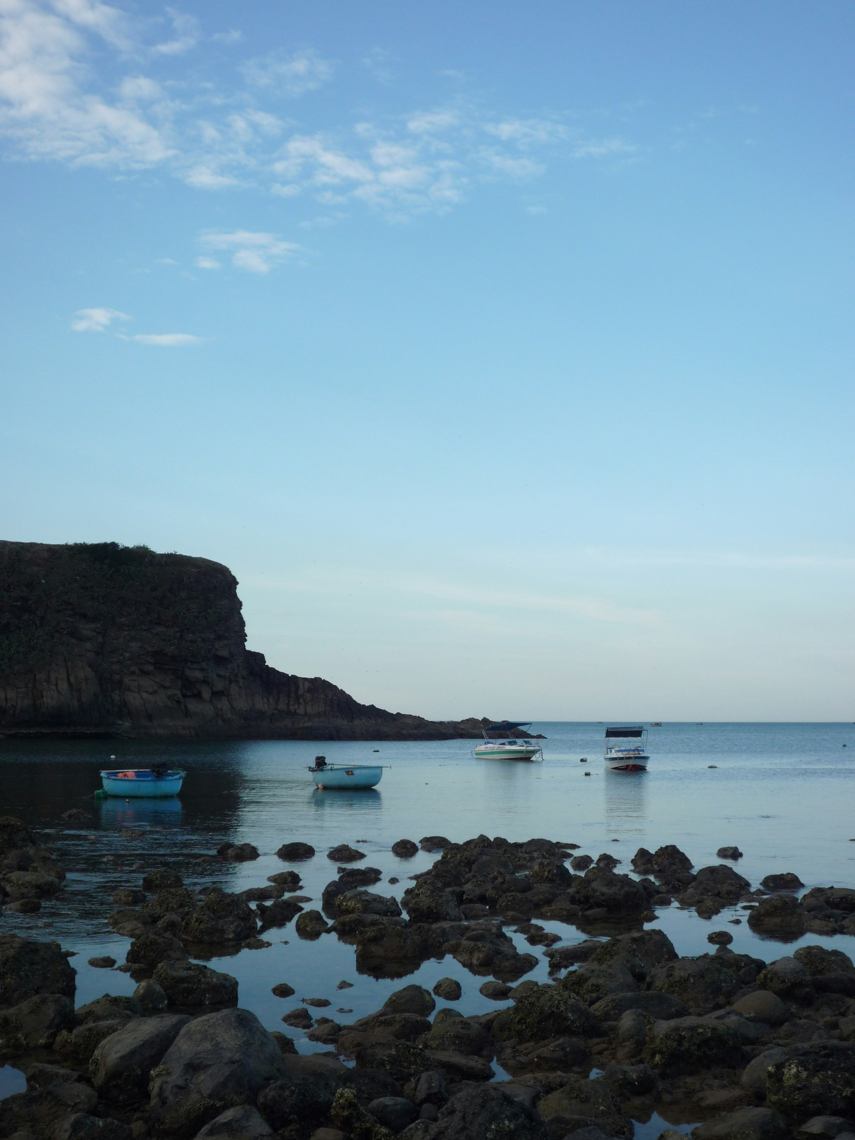 Quiet Cove Under a Wide Sky: Boats Rest at Dusk