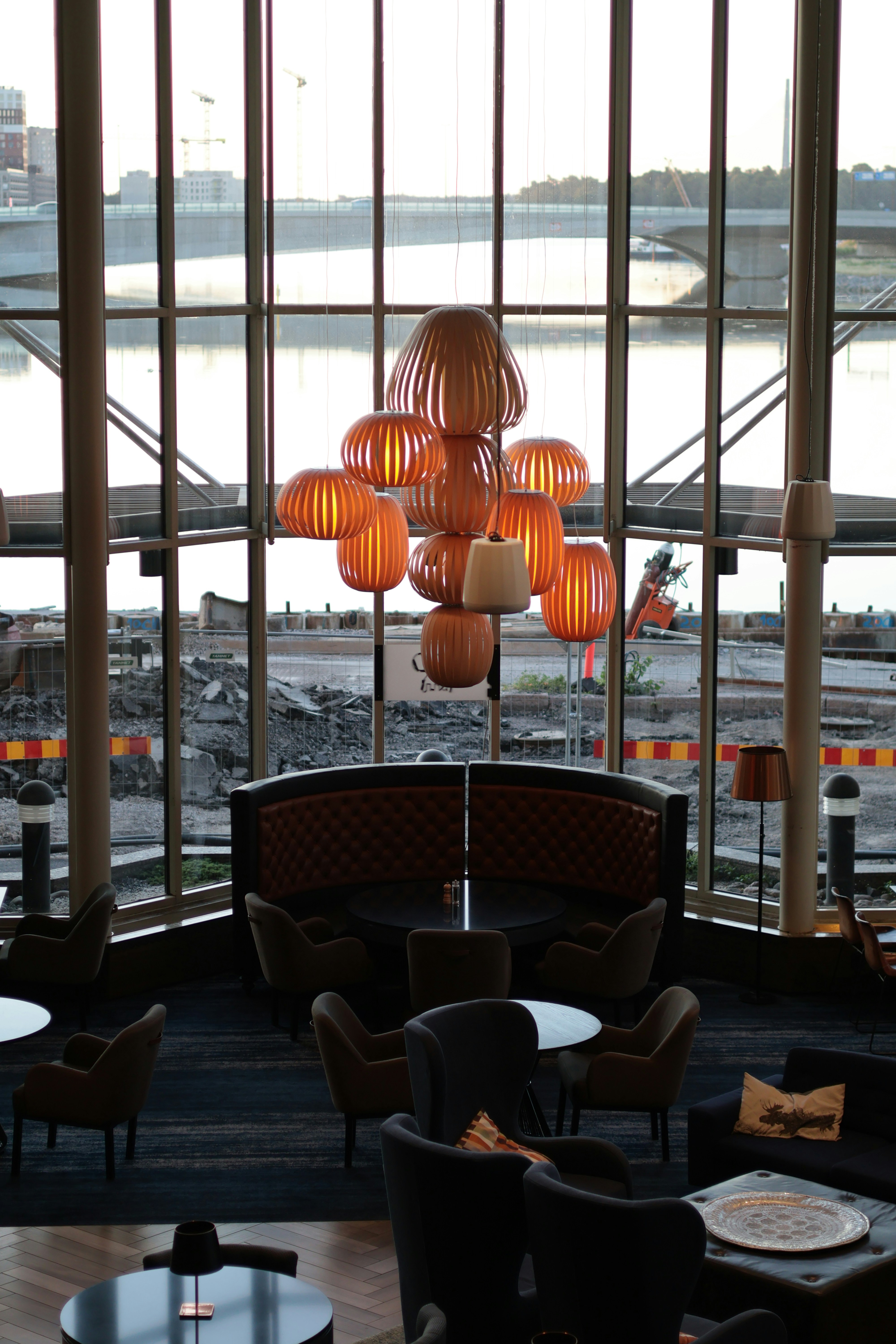 Orange Lanterns on Glass: Quiet Lounge Overlooking the Riverfront