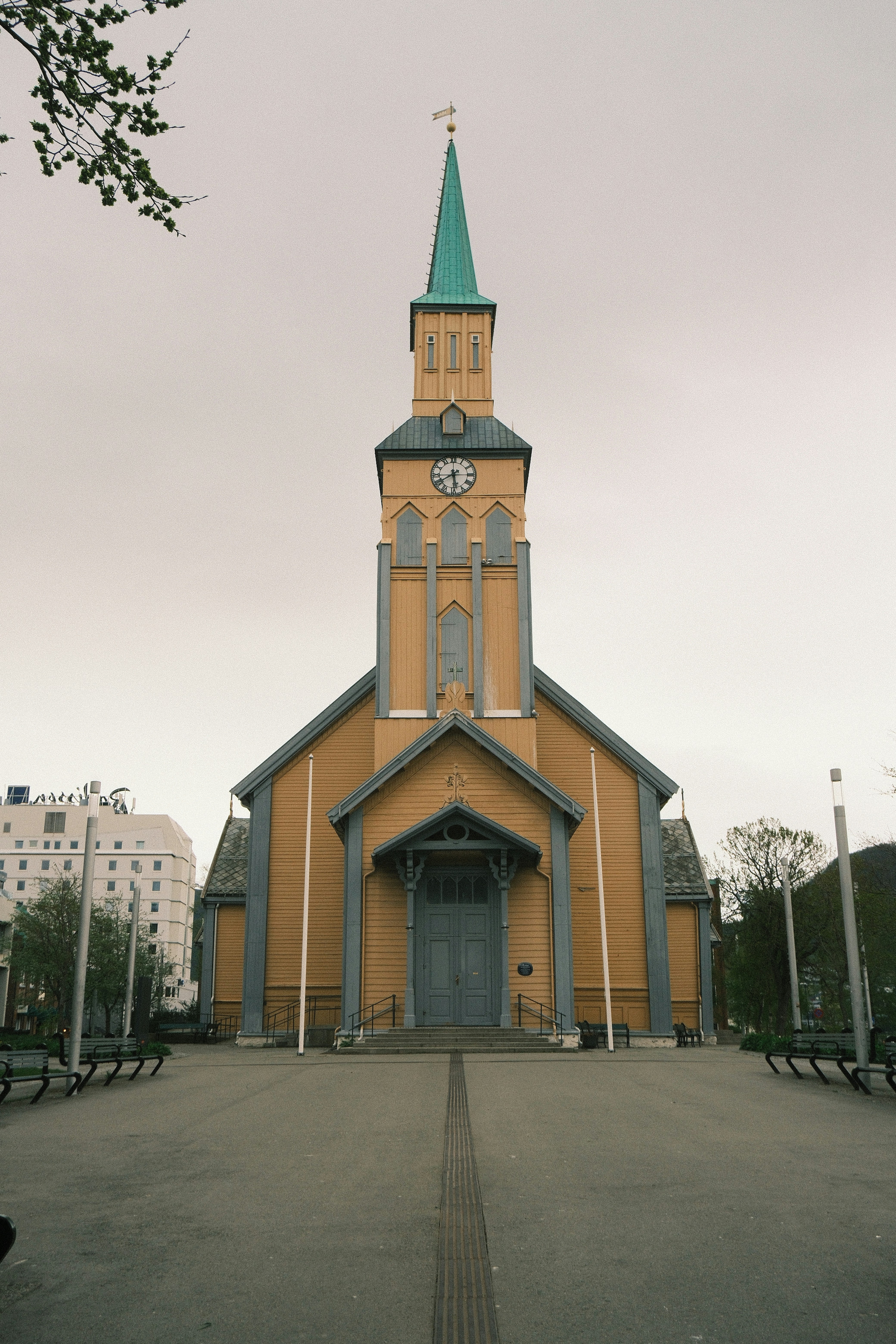 Sunlit Wooden Church Rising Against a Pale Sky