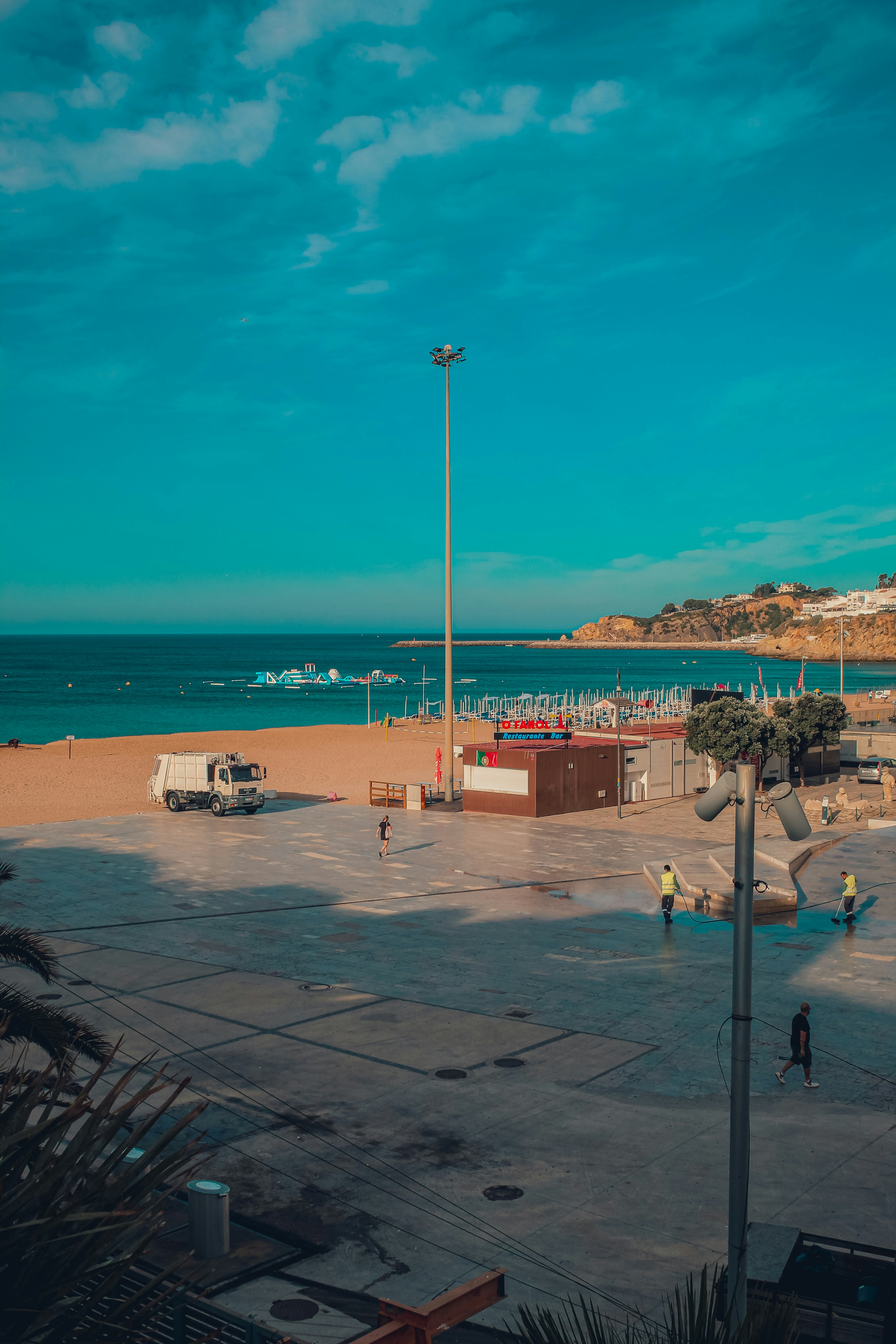 Coastal Promenade Under a Clear Teal Sky