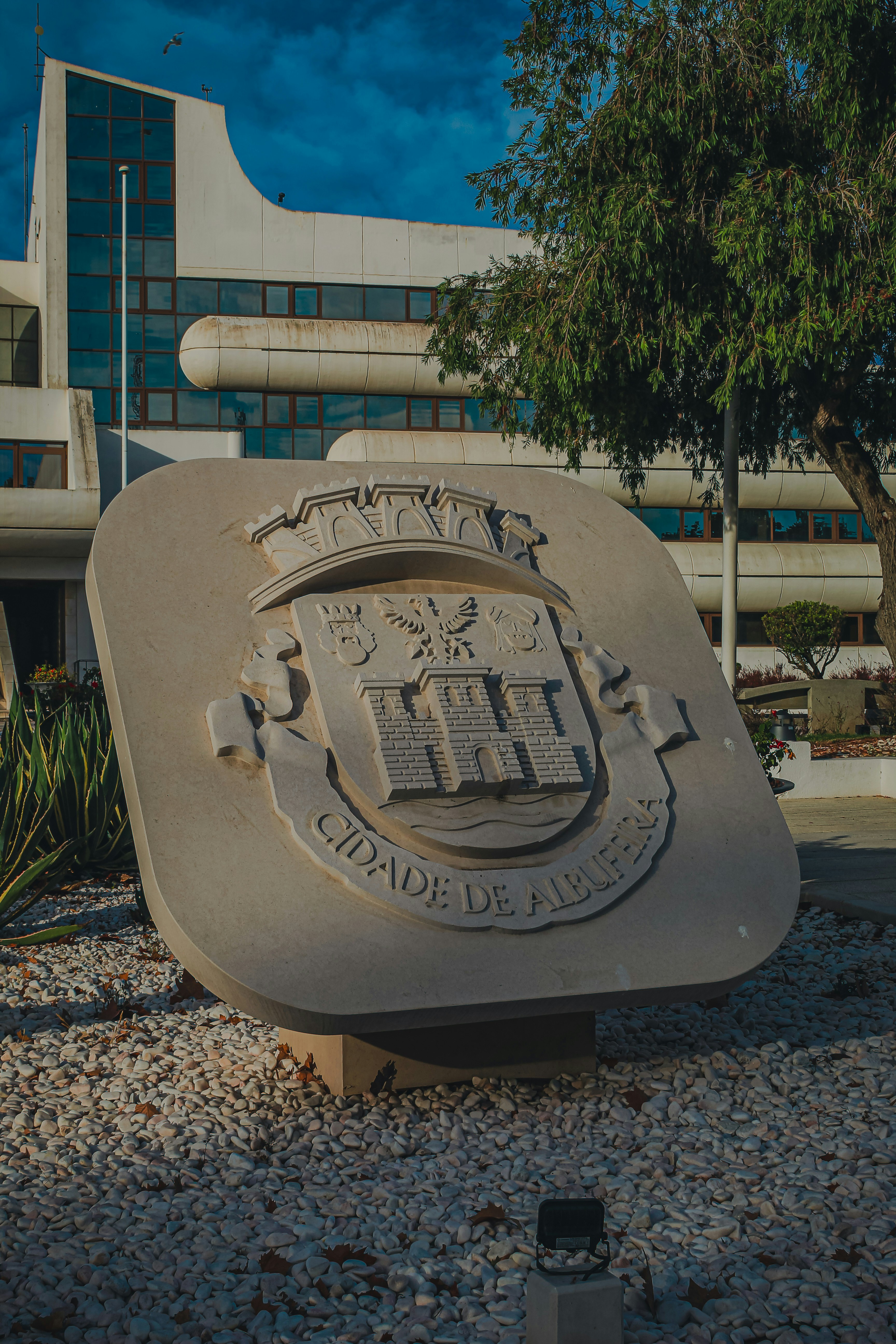 Stone Emblem in a Modern Campus: A Monumental Portrait