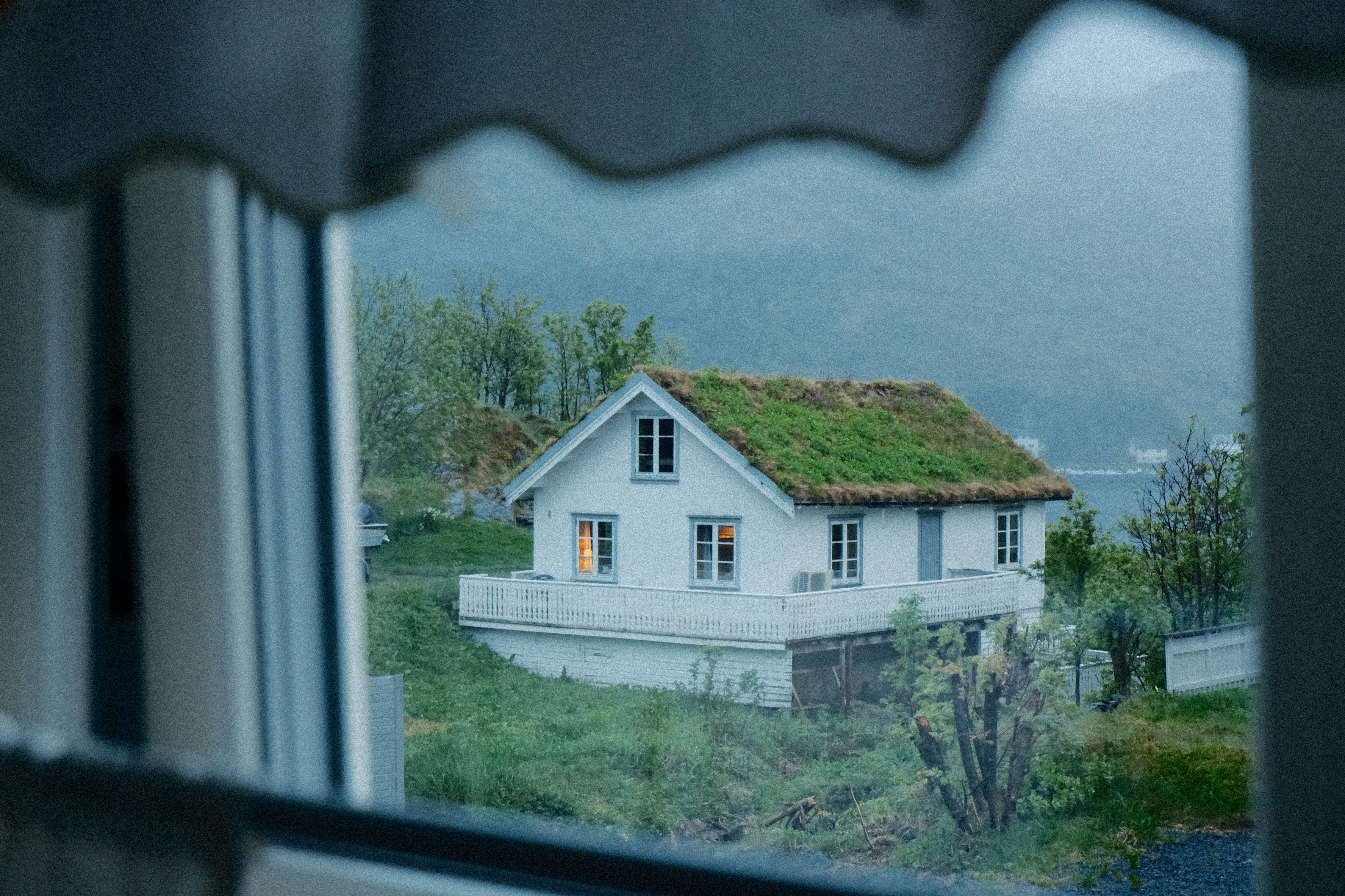 Cozy hillside retreat framed by window arches
