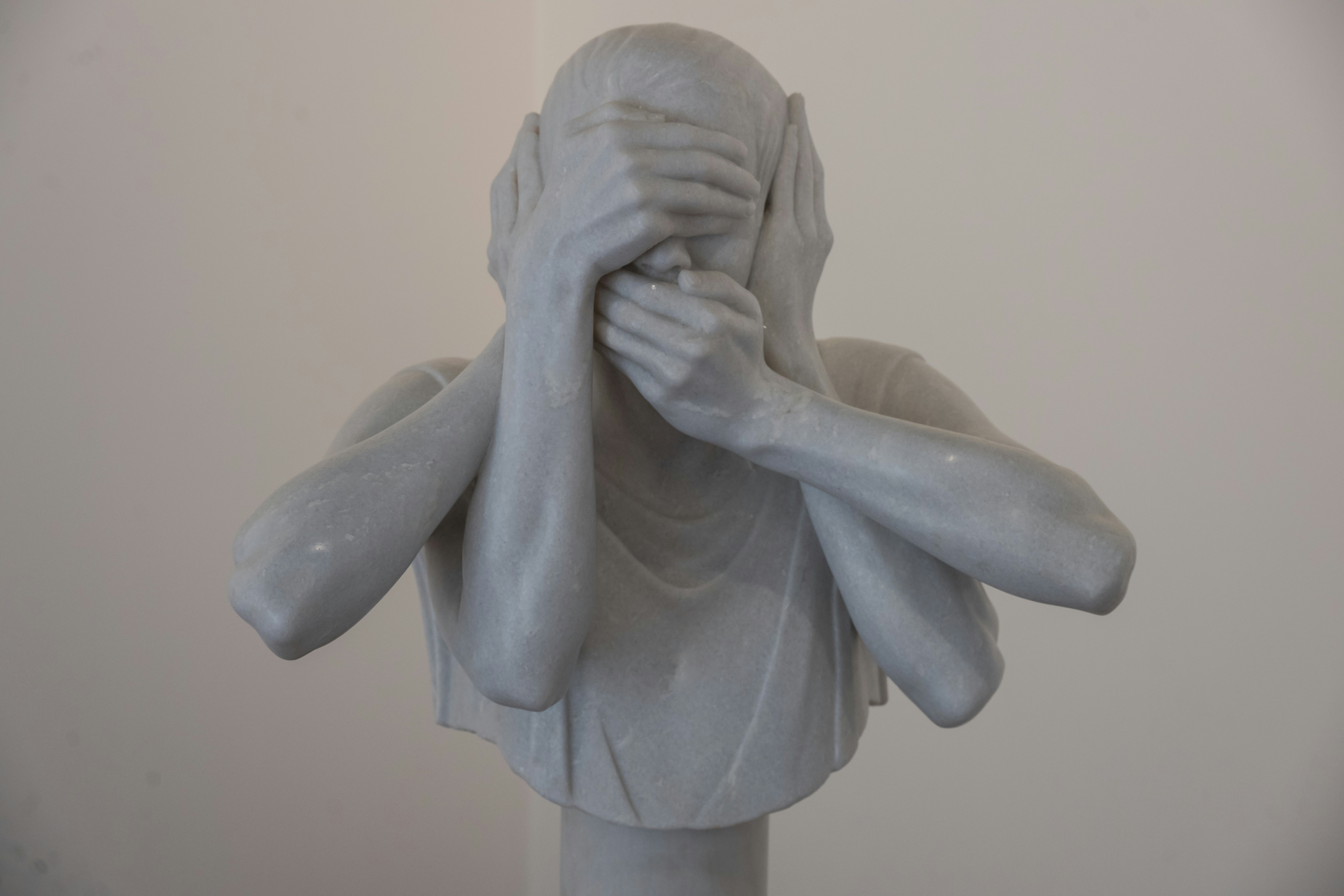 Silent Echoes: A Blindfolded Sculpture Reaches Beyond the Frame