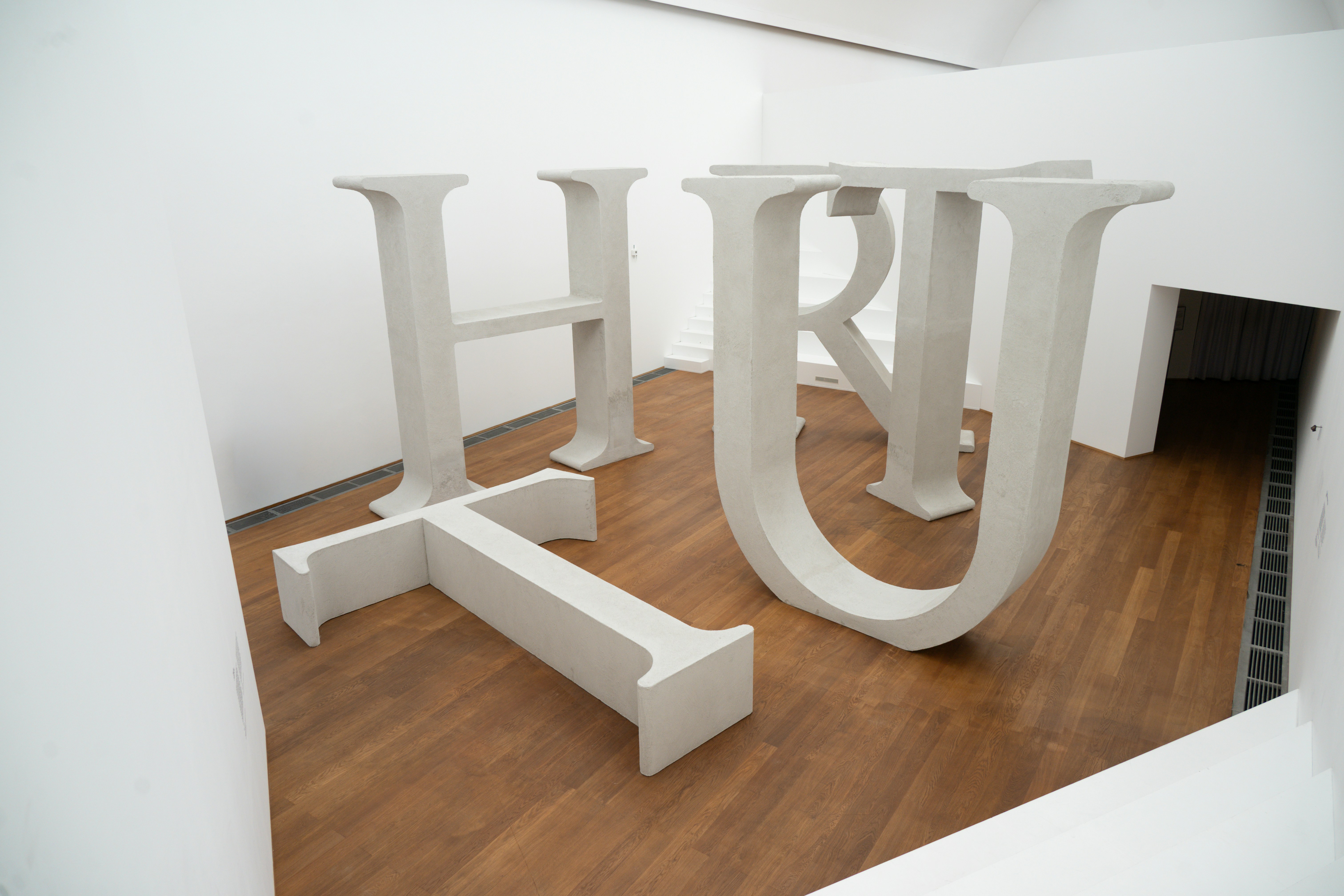 Monumental Letters Drape a Quiet Gallery Floor