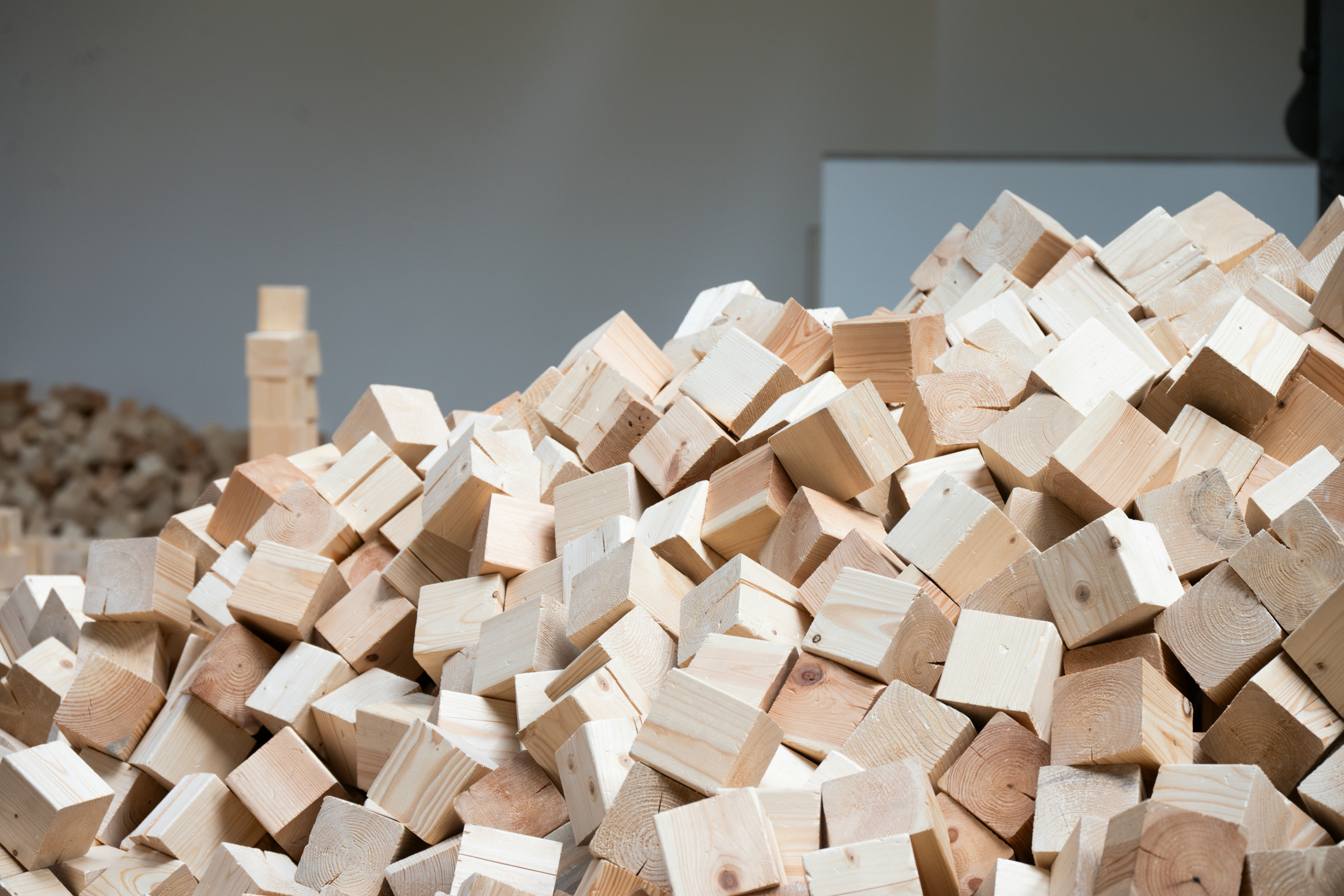Chipped Cedar Pile: An Assembled Mosaic of Lumber Under Soft Workshop Light