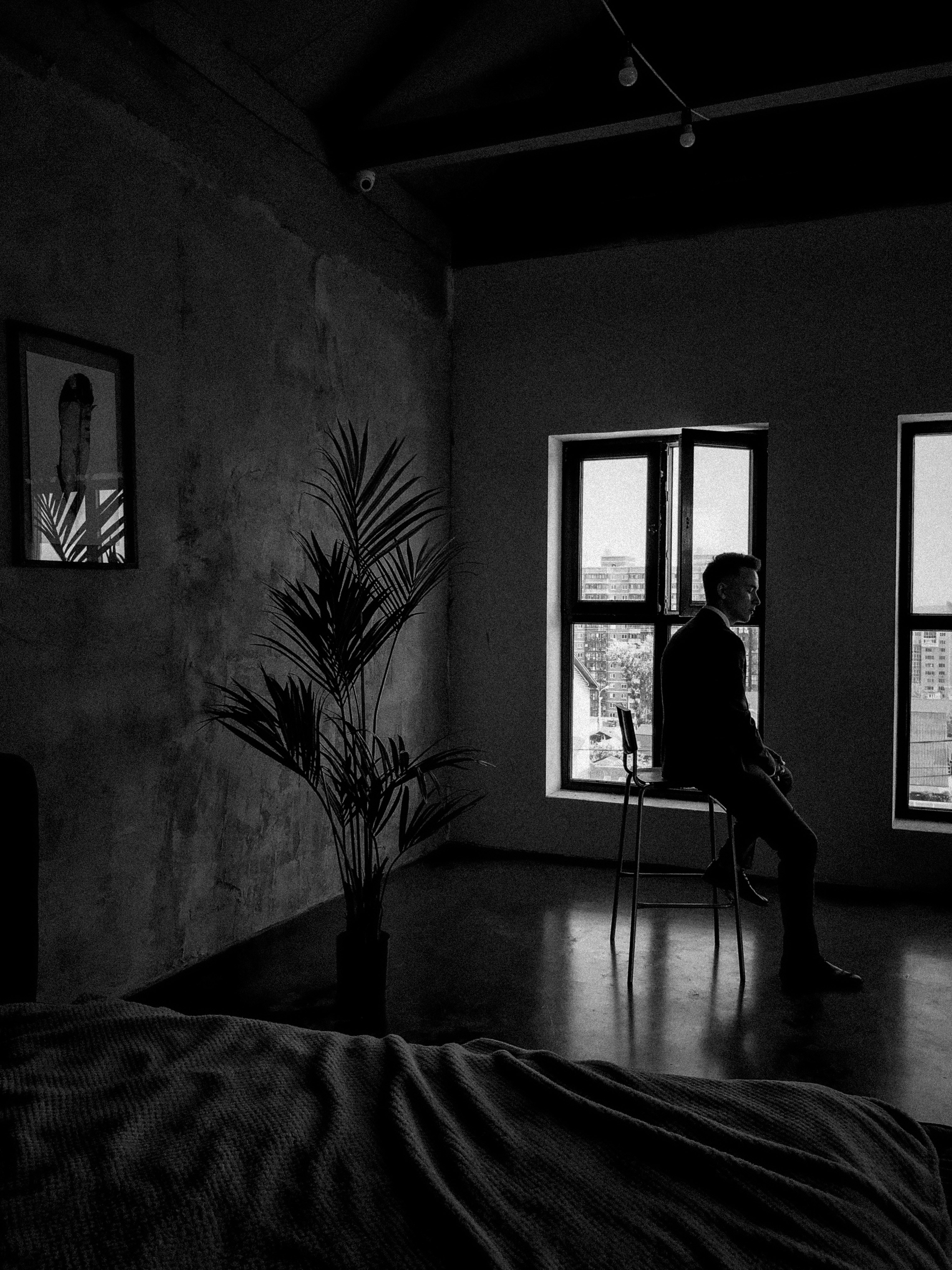 Silhouette of a Quiet Moment: Man in a Sunlit Studio