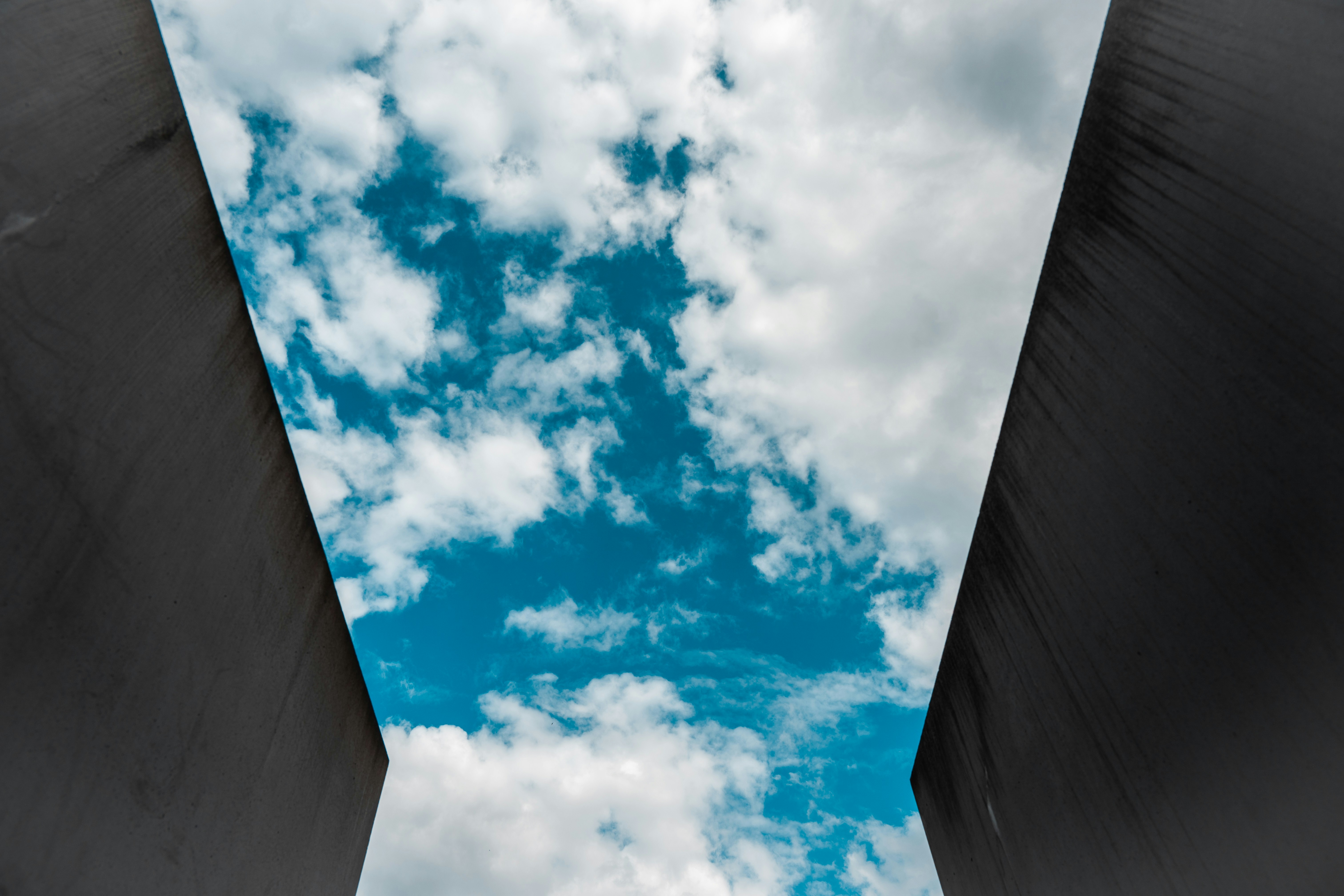 Skyward Gap: Blue Between Concrete Walls