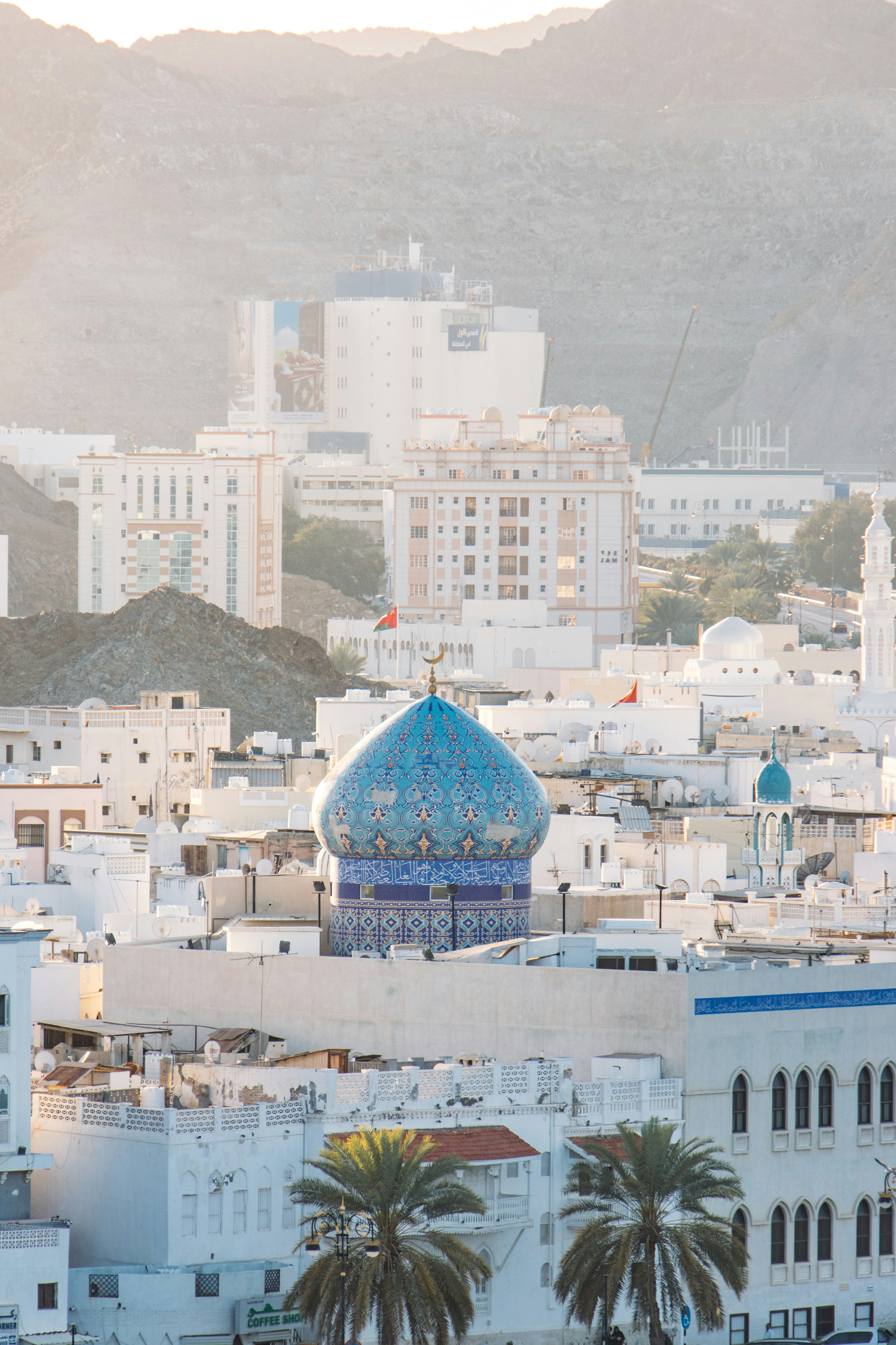 Blue-domed Mosque Silhouette Rising Above White Medina