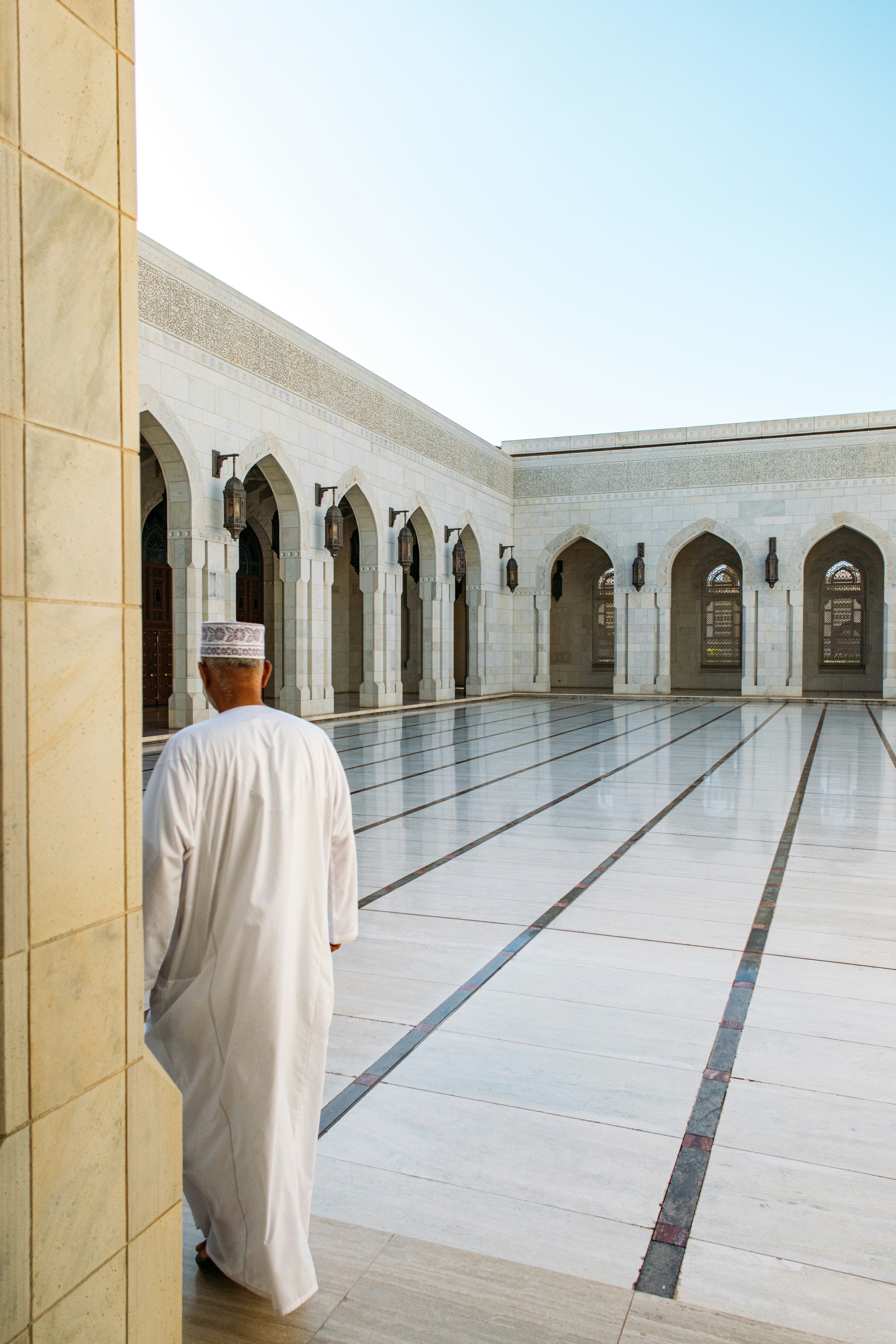 Lone Visitor in a Quiet Courtyard of Arched Marble