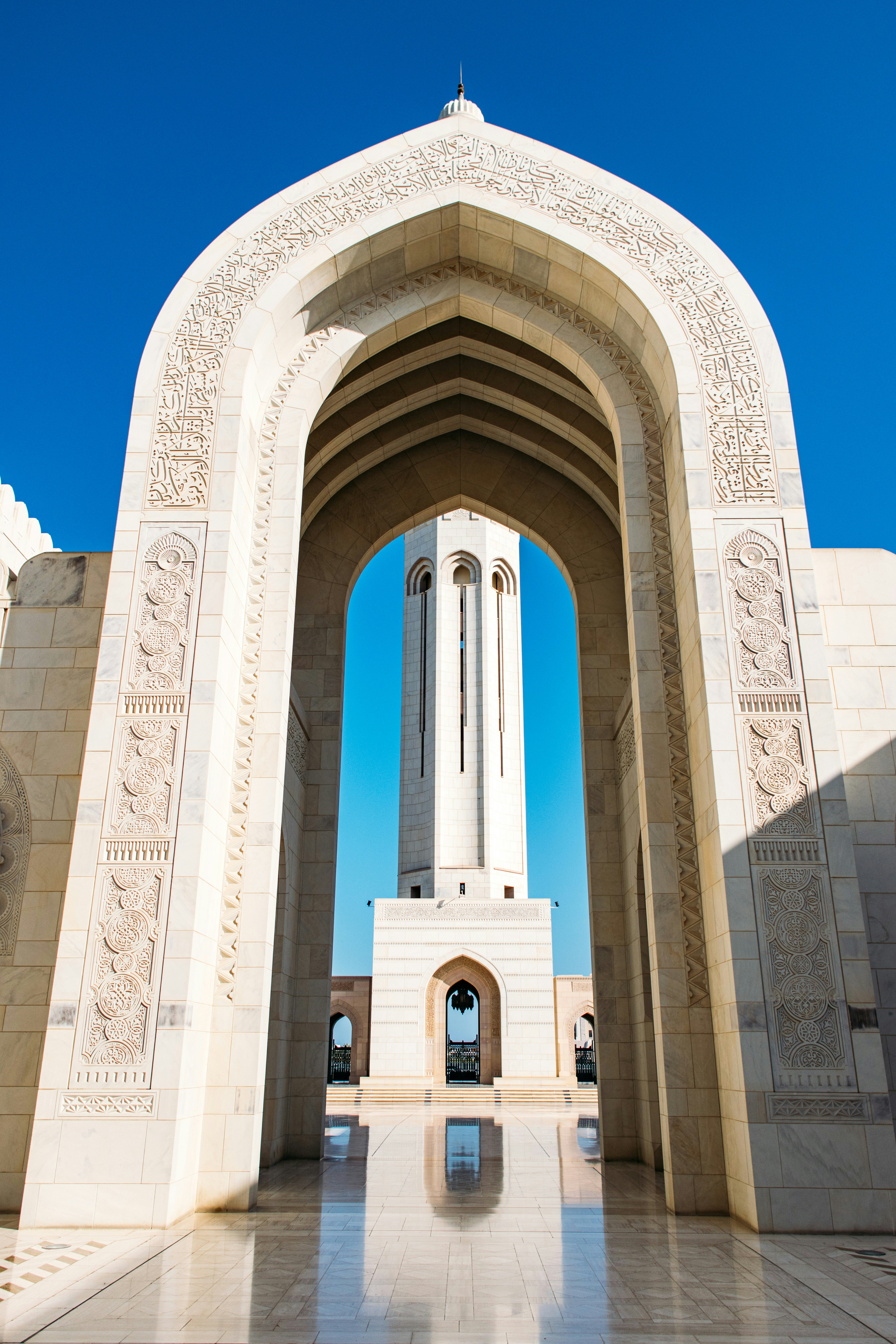 Archway to the Minaret: Symmetry and Light Under Blue Sky