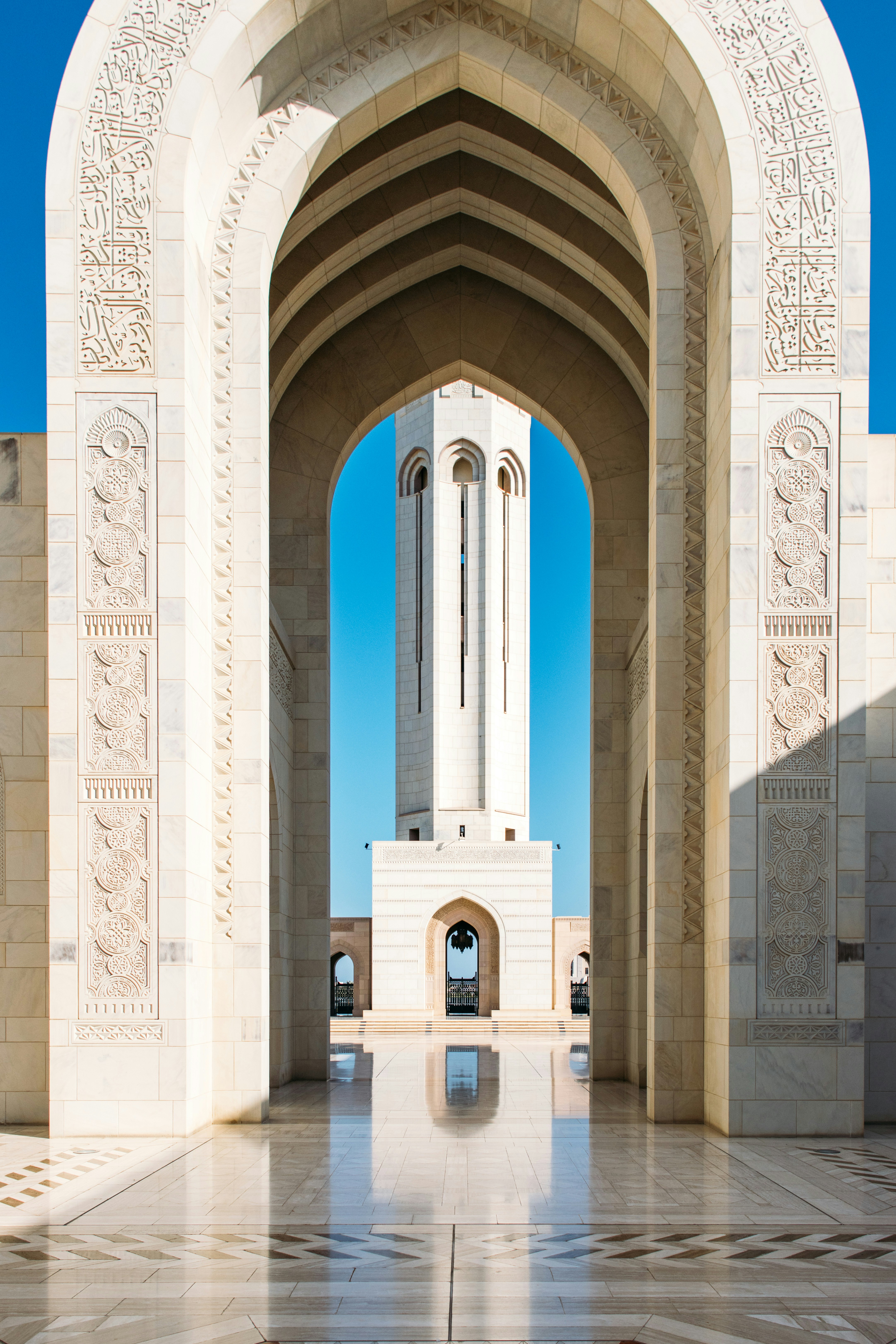 Archway to Light: A Monumental Corridor Framed by Silent Spires