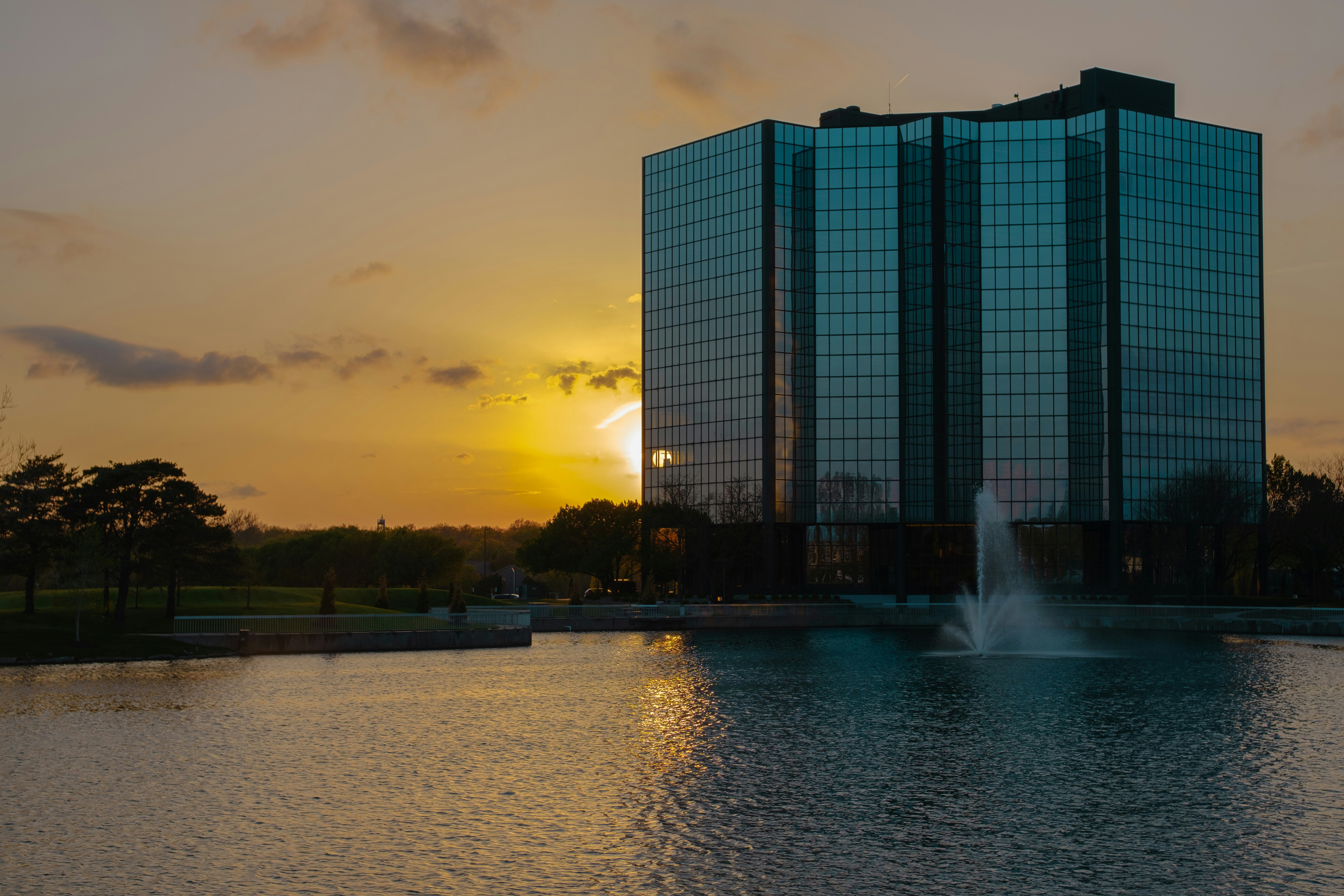 Sunlit Glass Tower Dusk Over Quiet Water