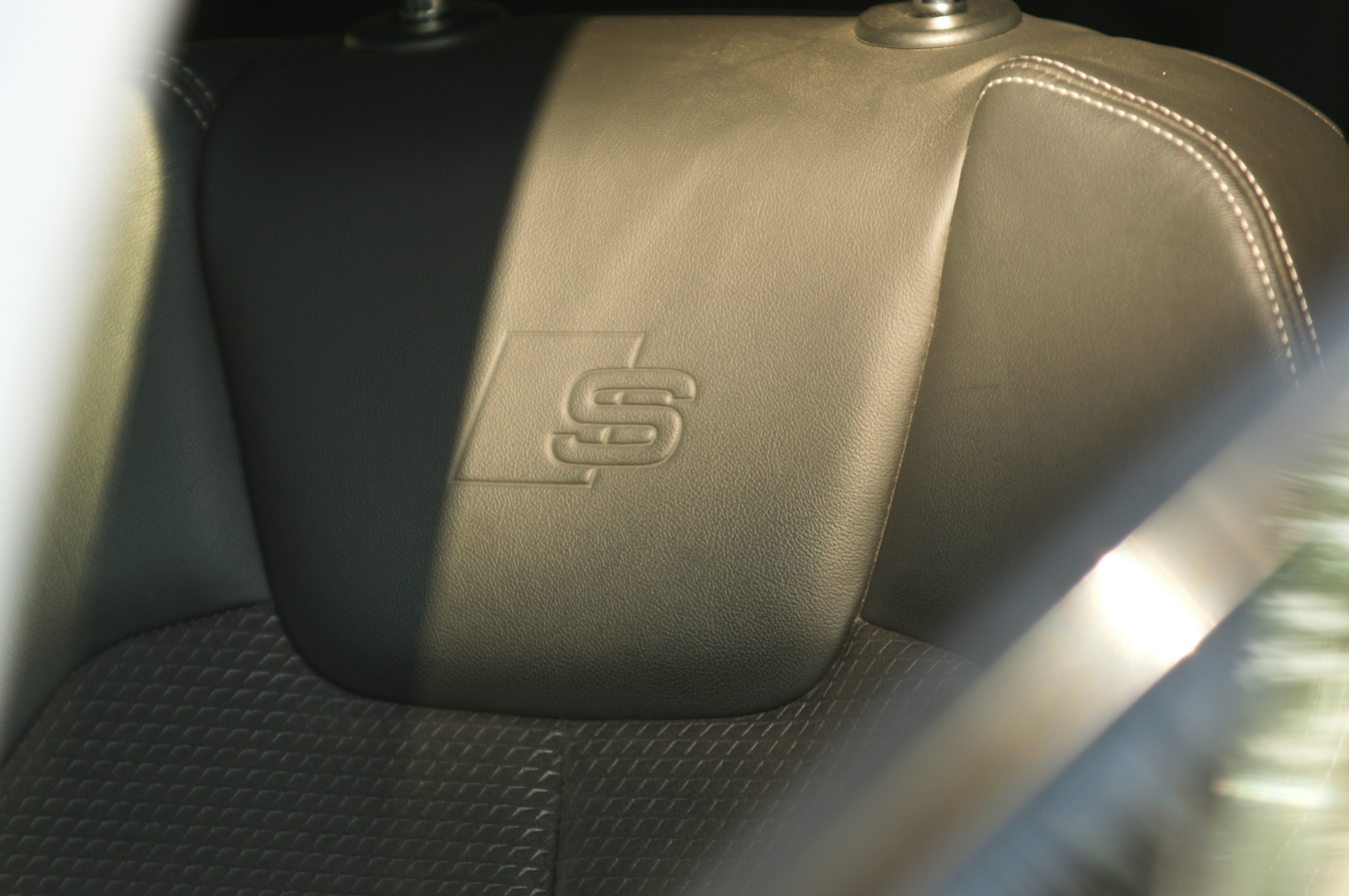  embossed seat emblem in a sunlit car interior