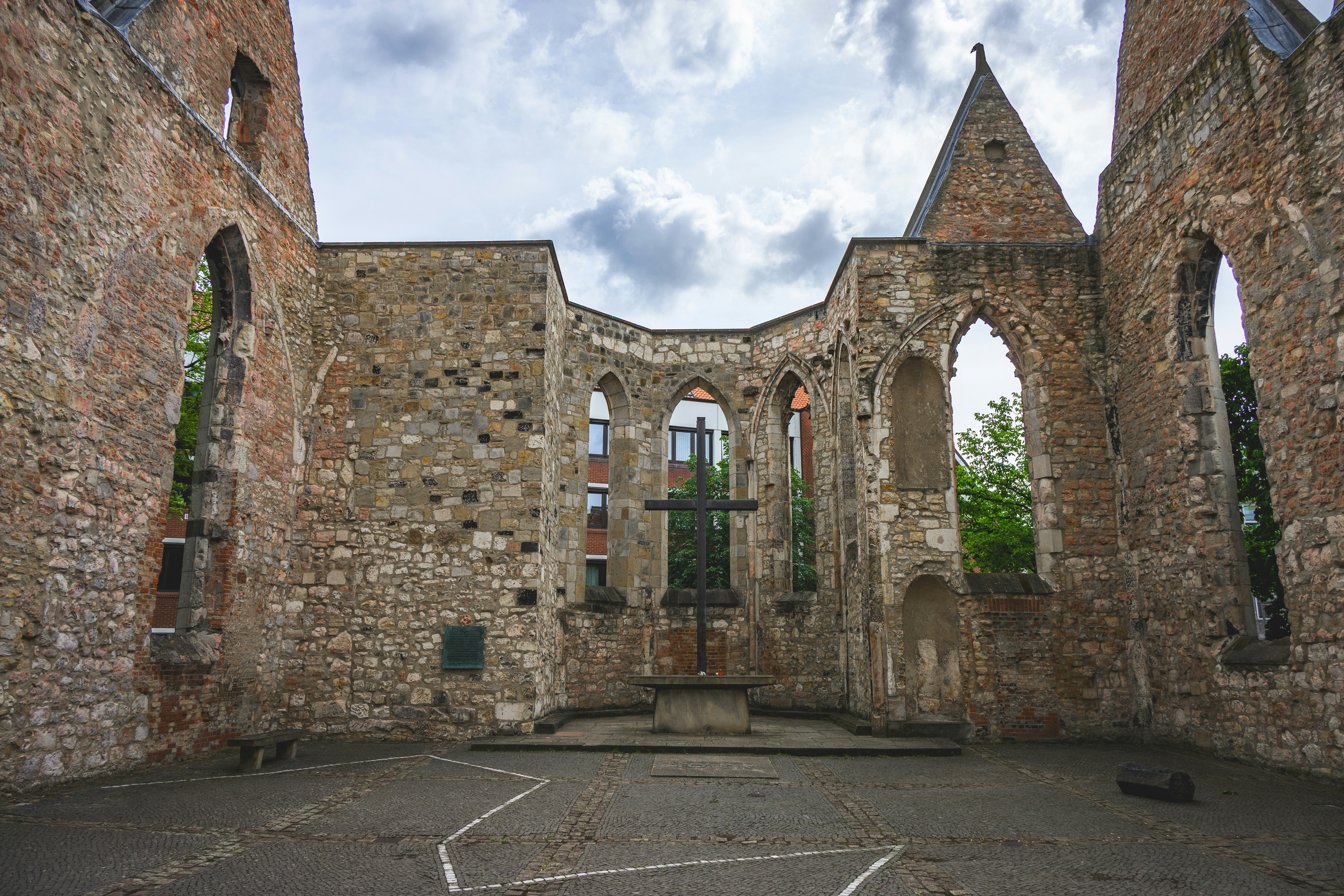 Ruins of Stone Cathedral: Framed Windows and Central Altar in Weathered Courtyard