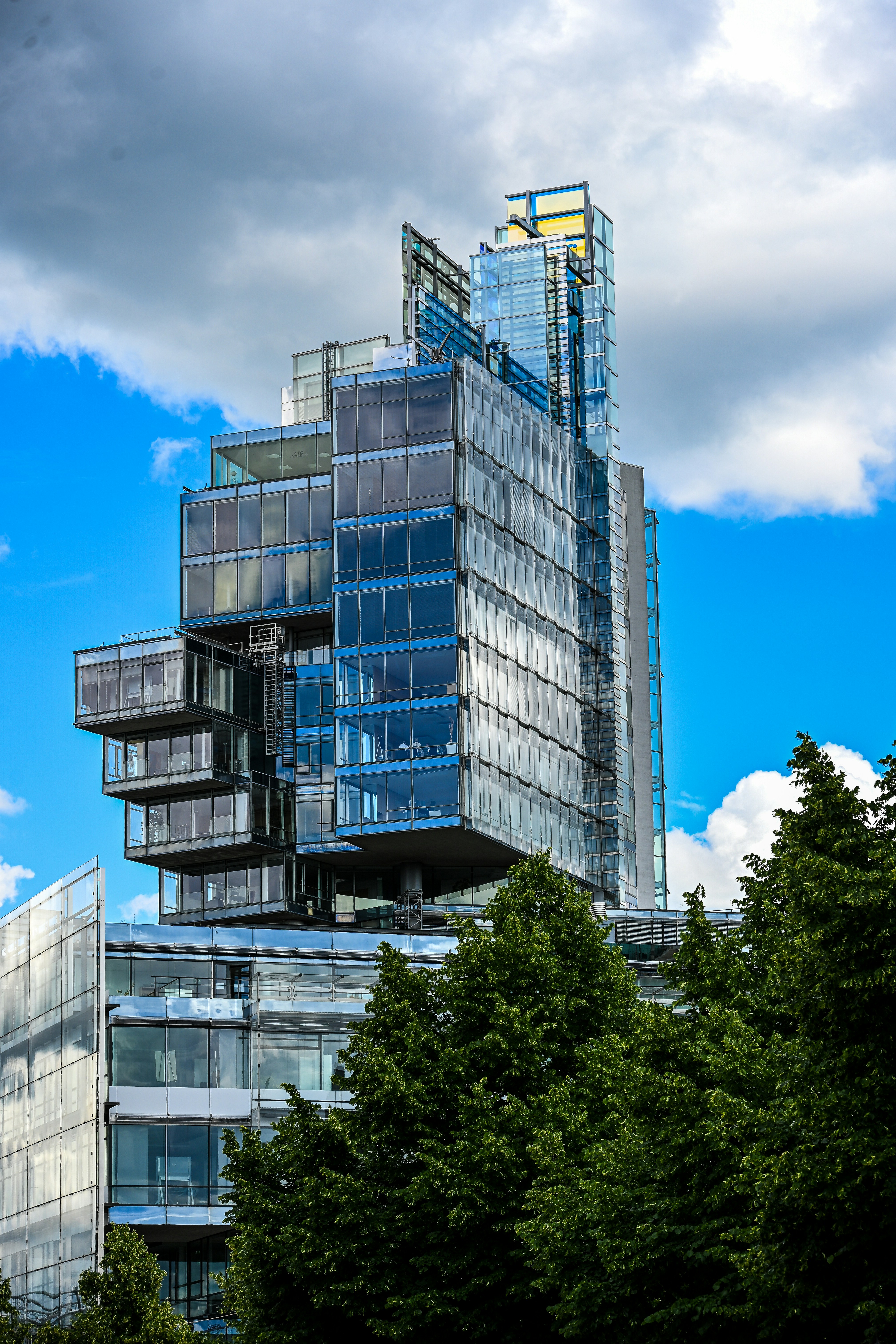 Skyward Block: A Glass Odyssey Rises Over Green Canopies