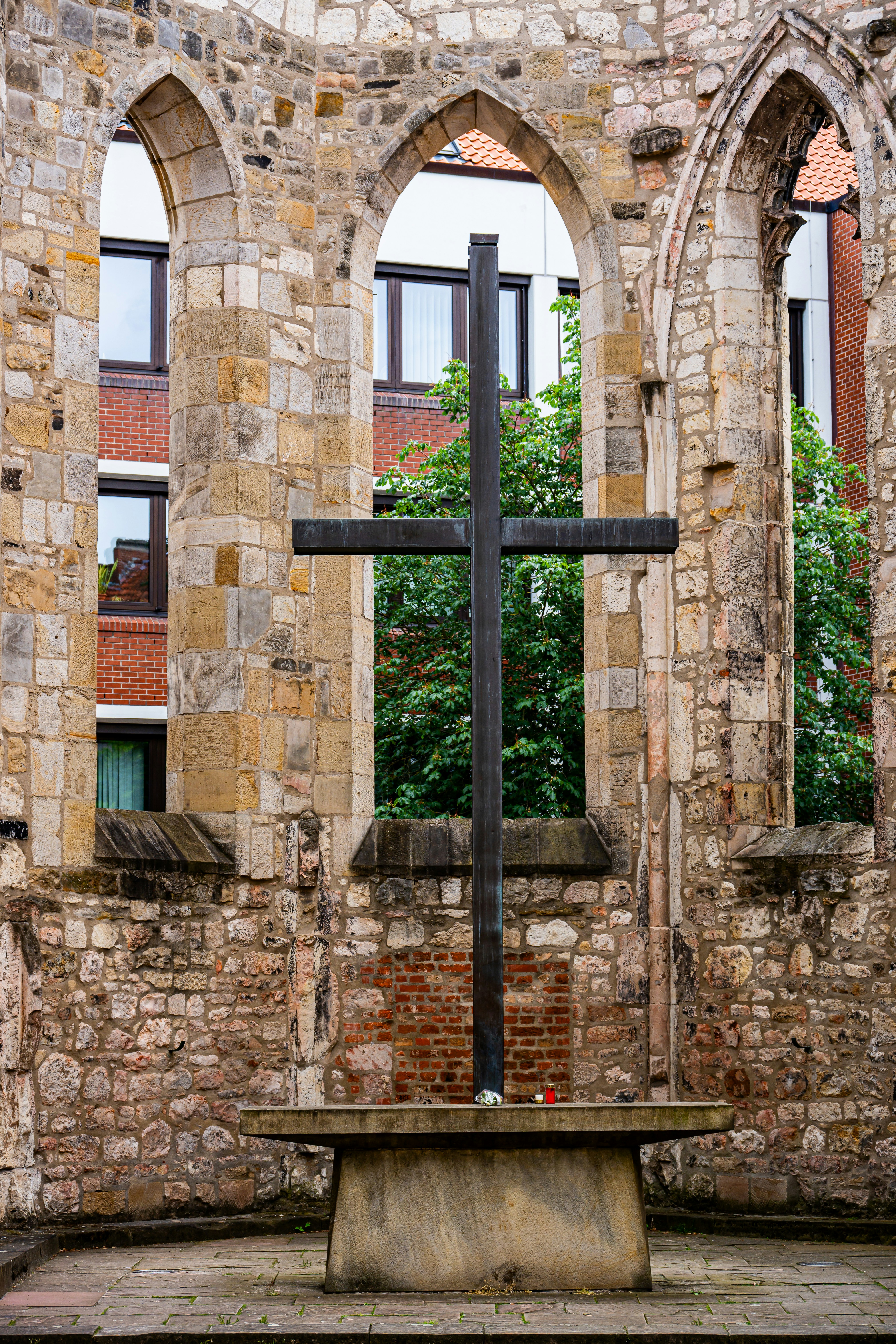 Stone Ruin Shrine: A Leaning Cross Framed by Historic Arches