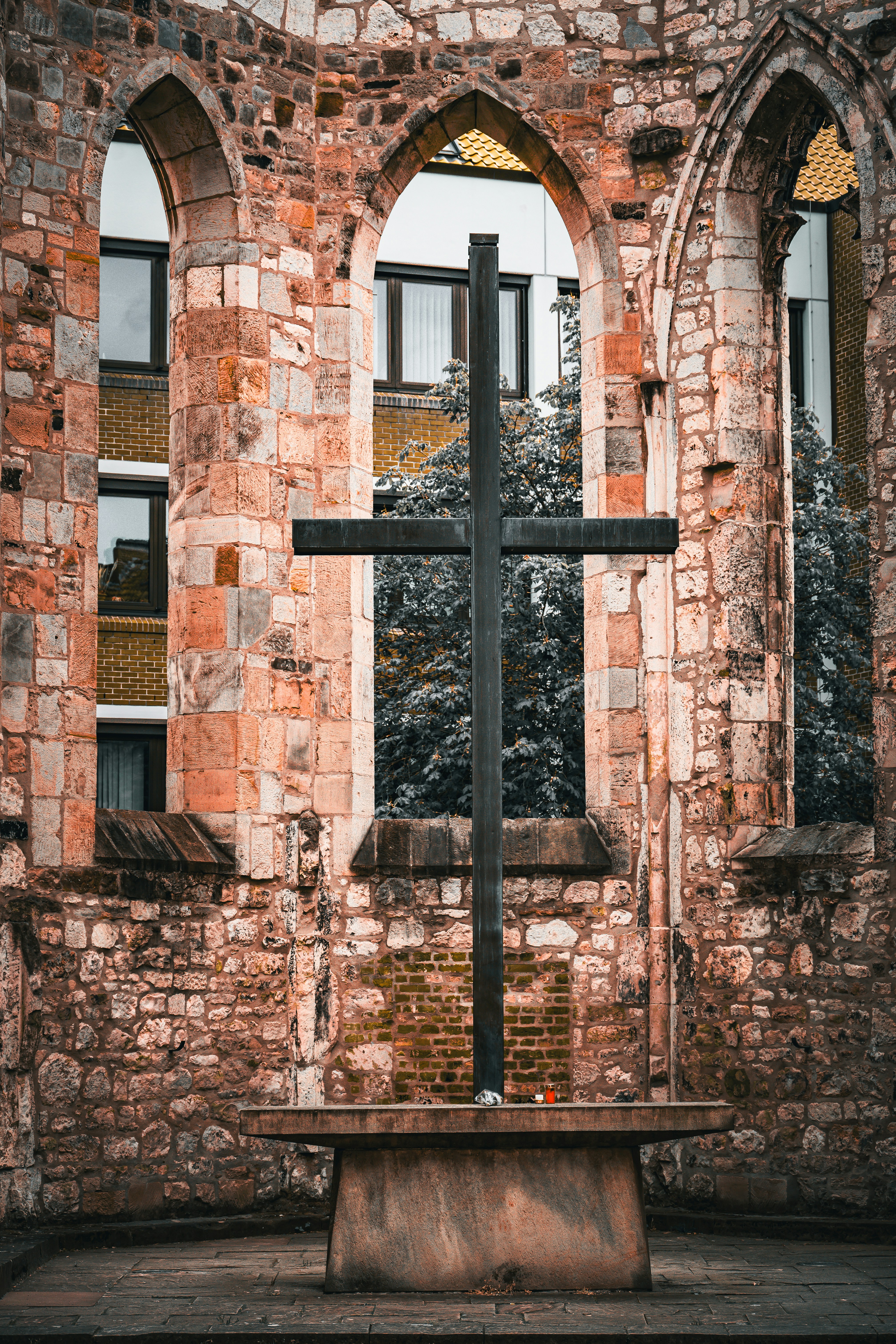 Cross of Memory: An Ancient Altar Beneath Arched Brickwork