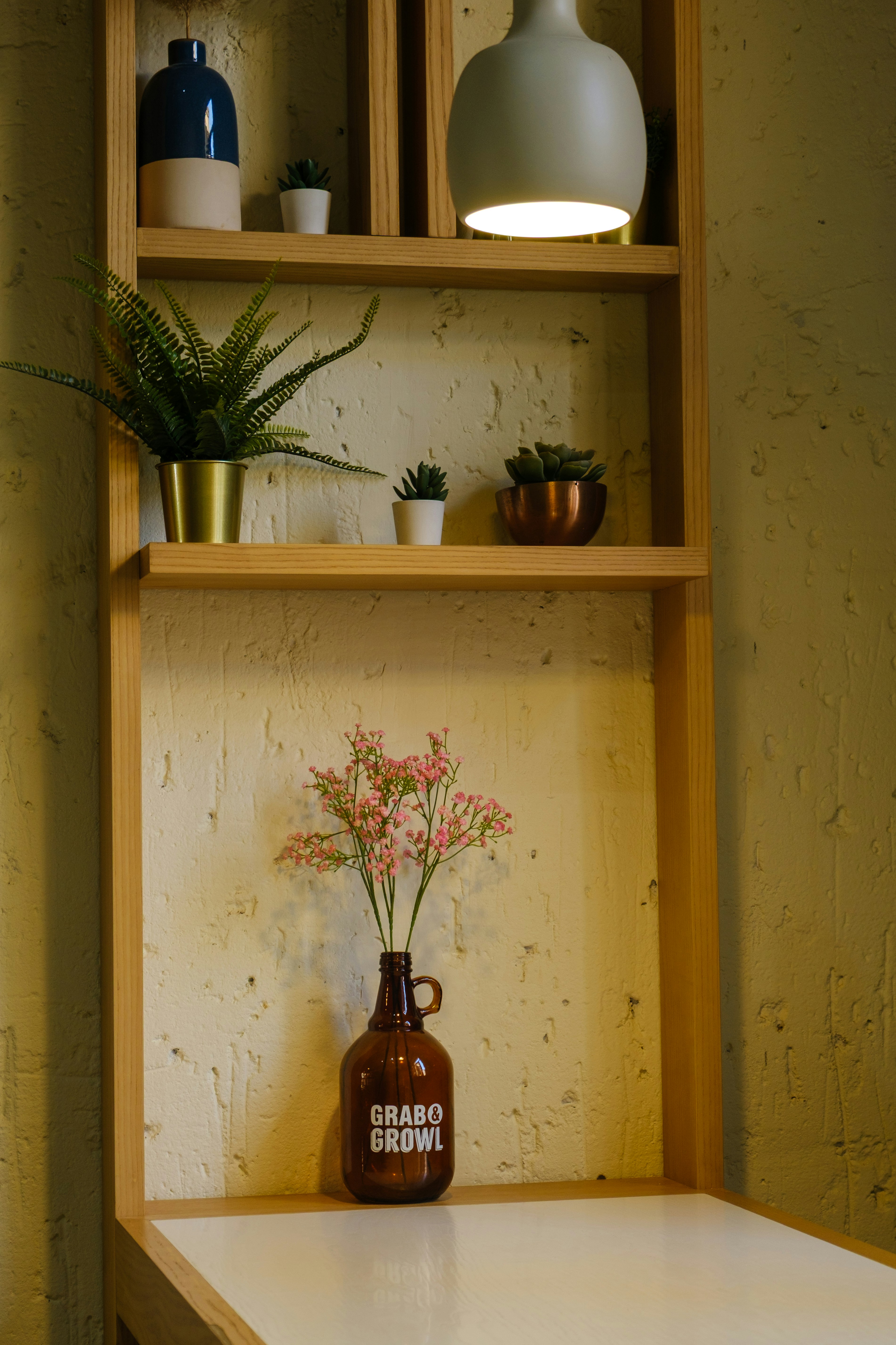 A Quiet Corner: Potted Greens and a Vintage Bottle of Blooms