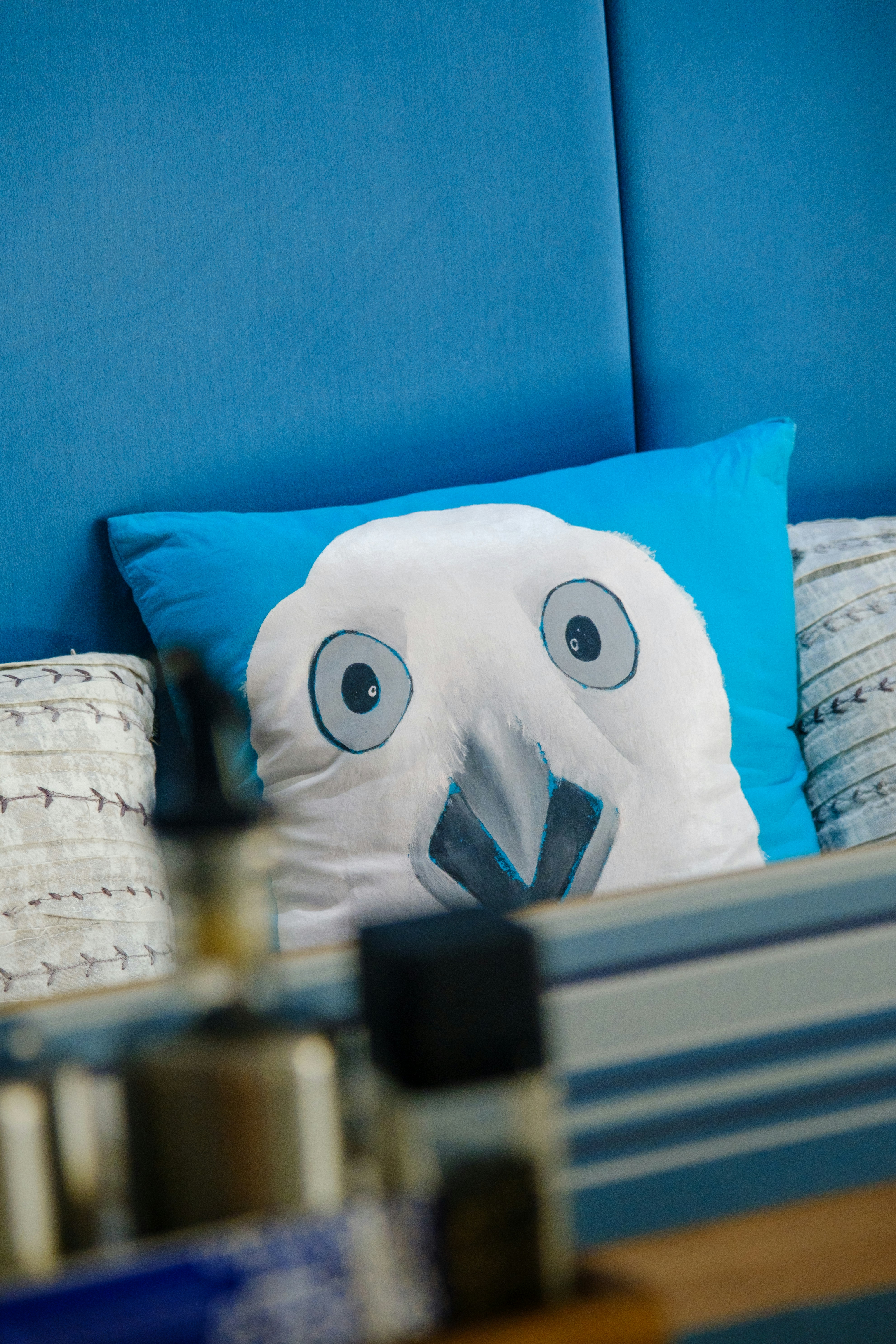 Blue Cushioned Face: A Cozy Emoji Pillow on a Bright Set