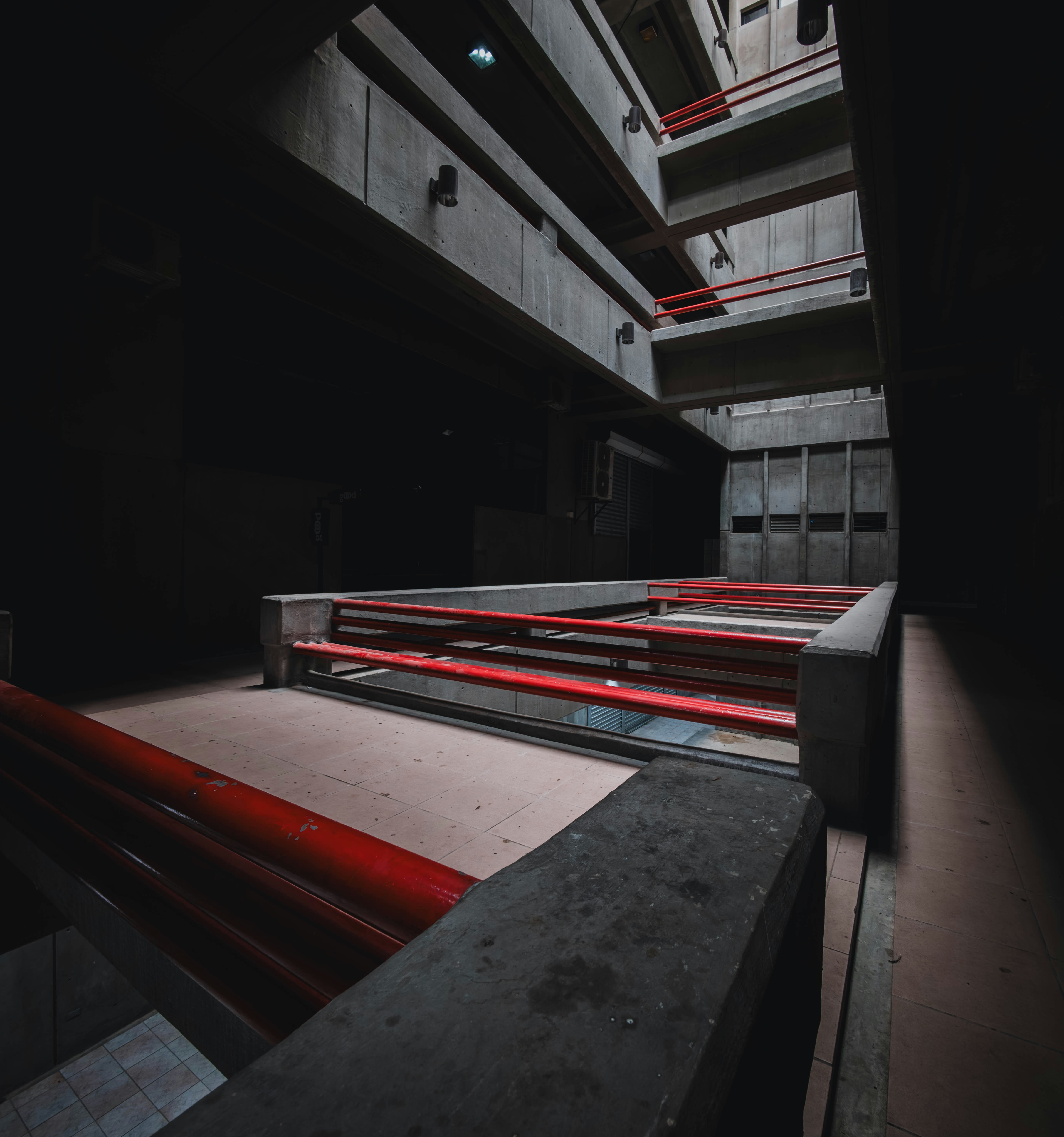 Red Railing Echoes in a Concrete Atrium