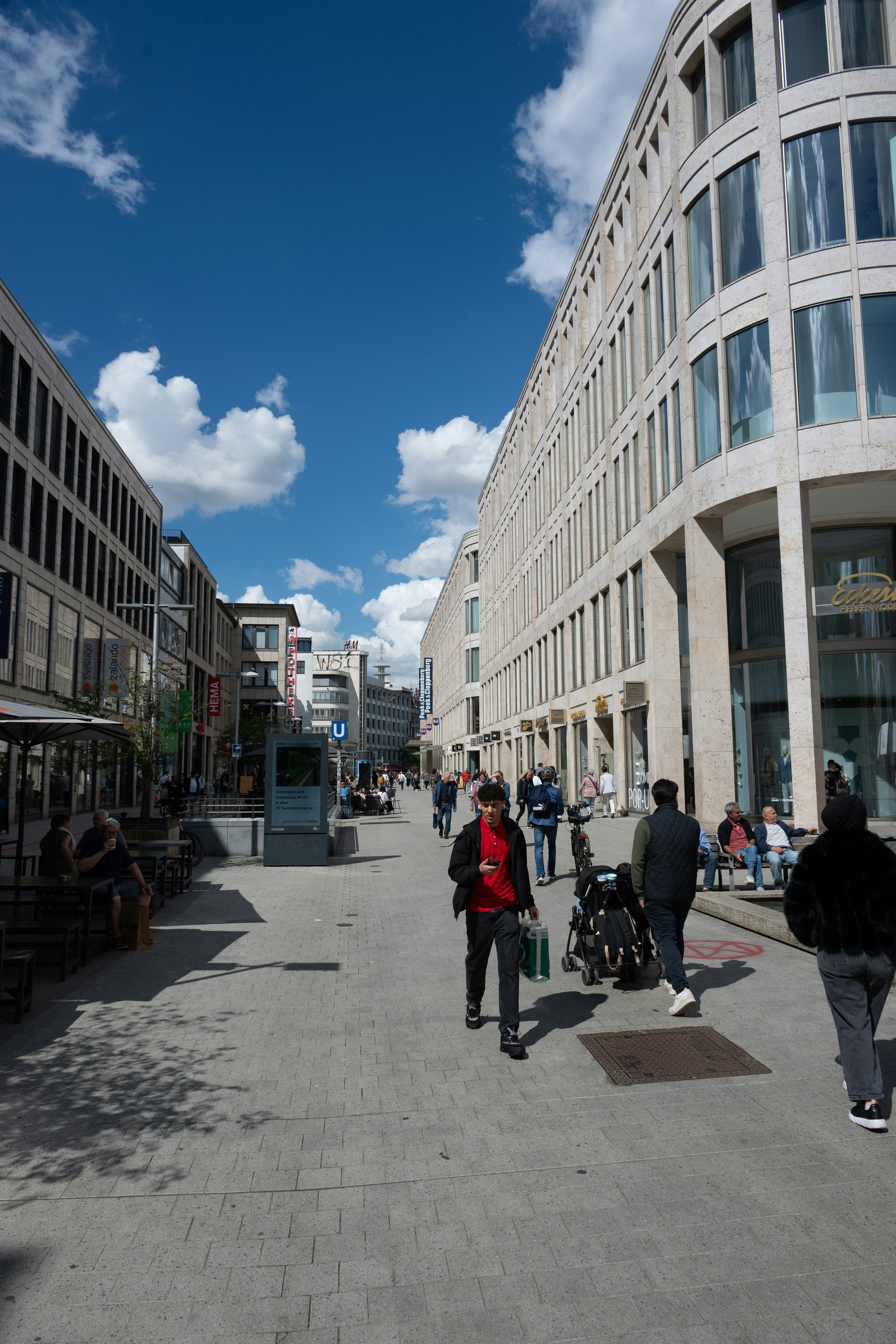 Urban Boulevard: People, Shadows, and Glass up the Street