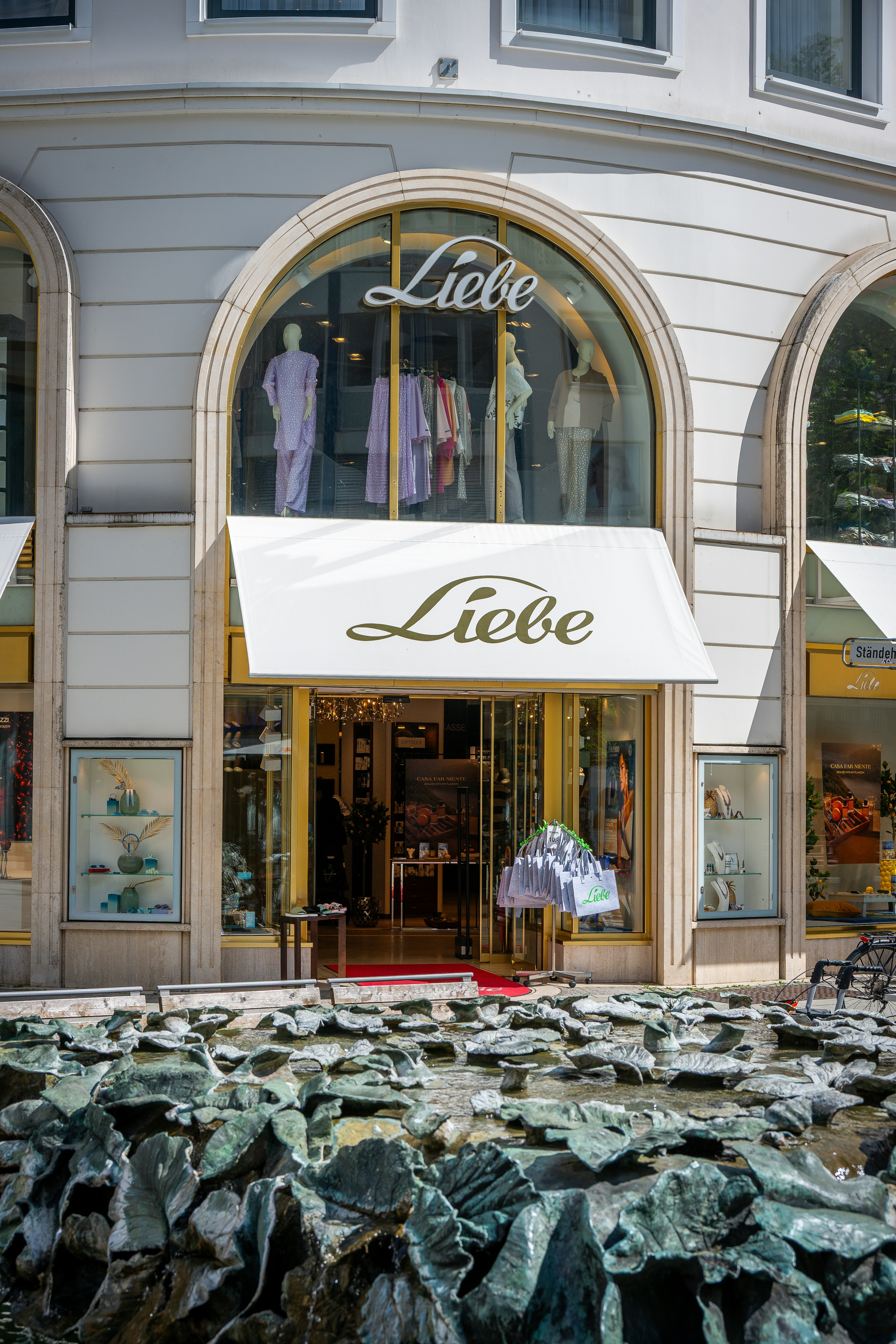 Graceful storefront window with the word Liebe above an inviting awning