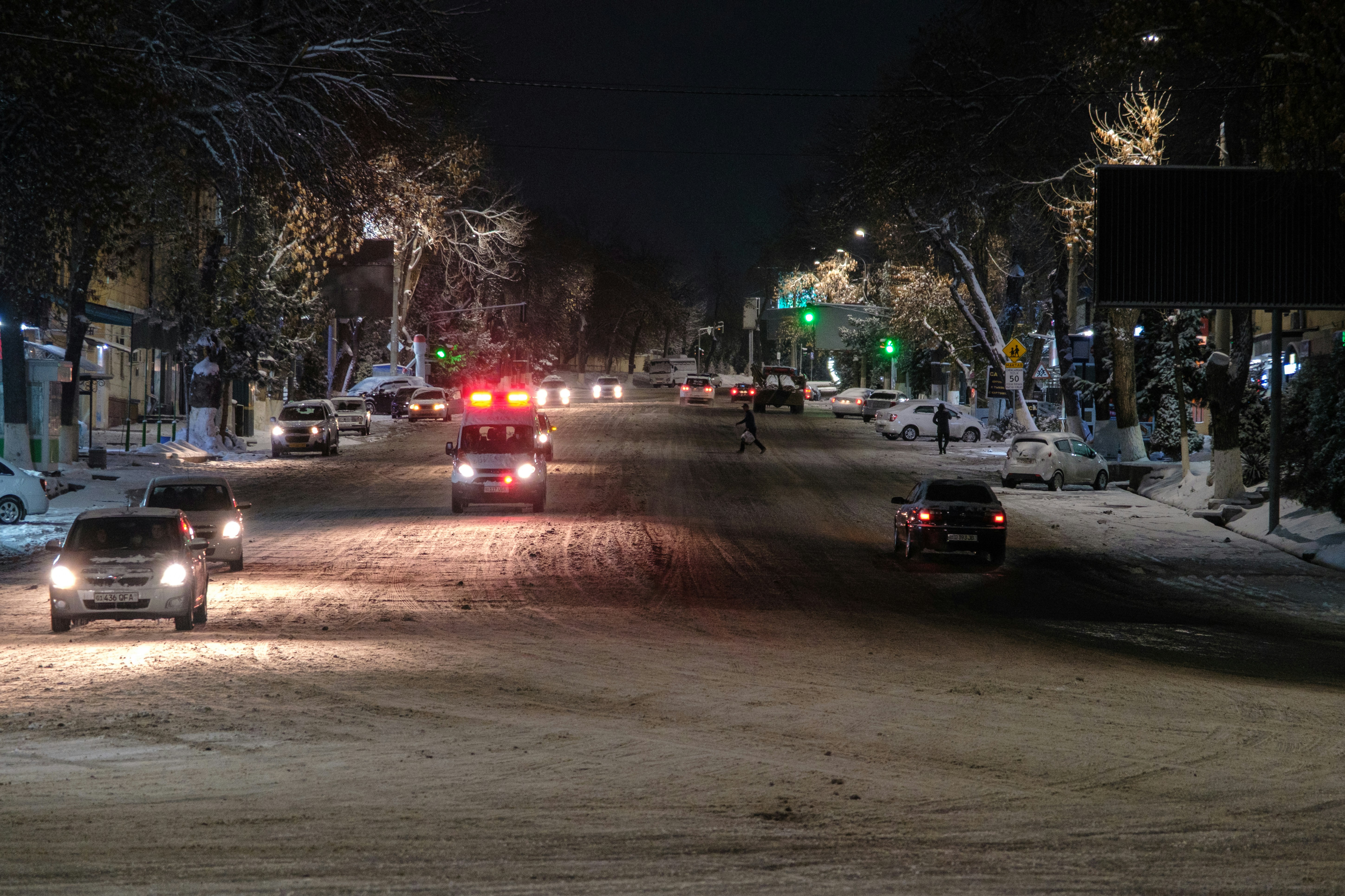 Snowy Street Midnight: Emergency Lights and Quiet Traffic