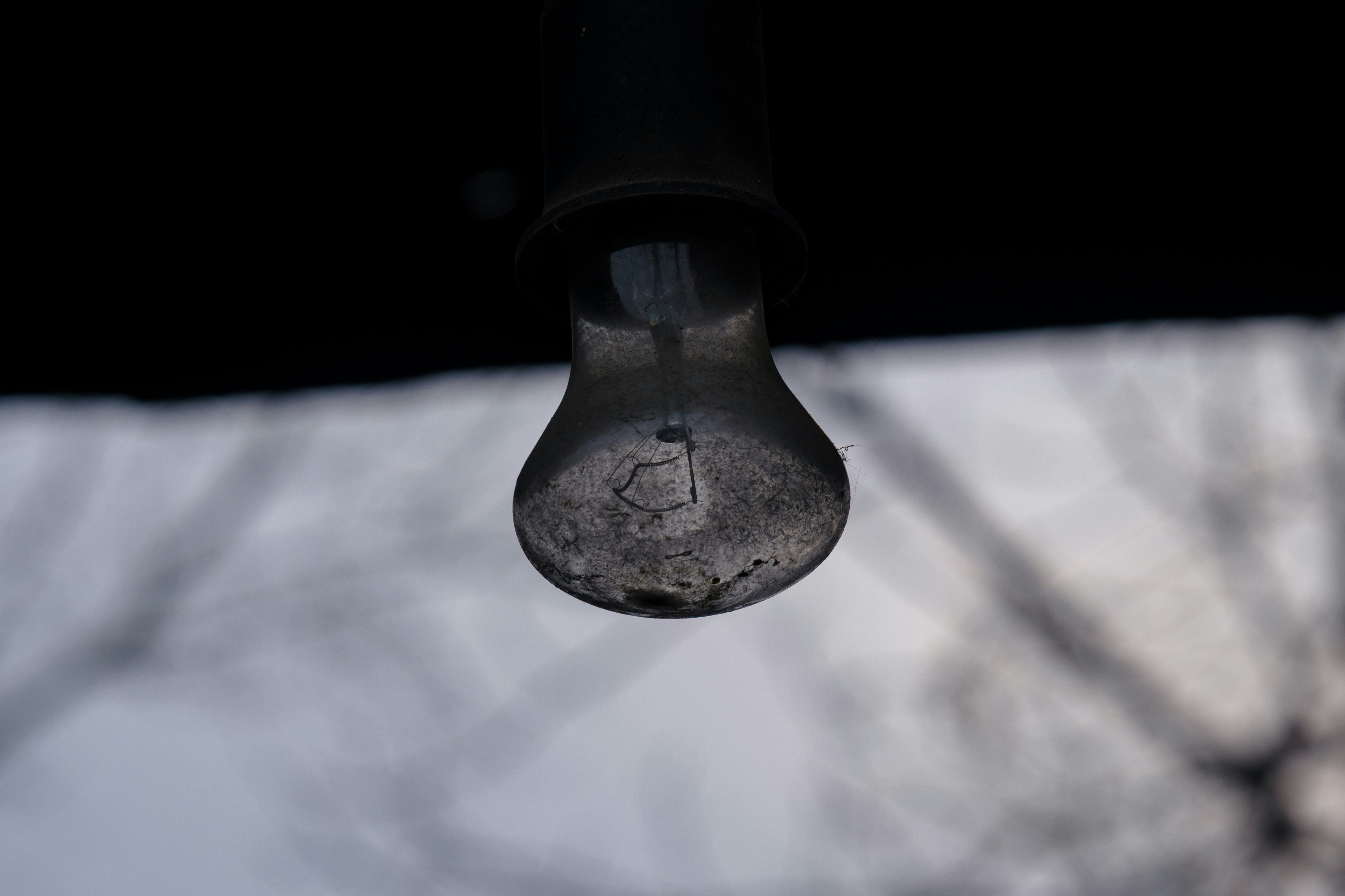 Watered Down Focus: A Faucet Spout in Winter Light