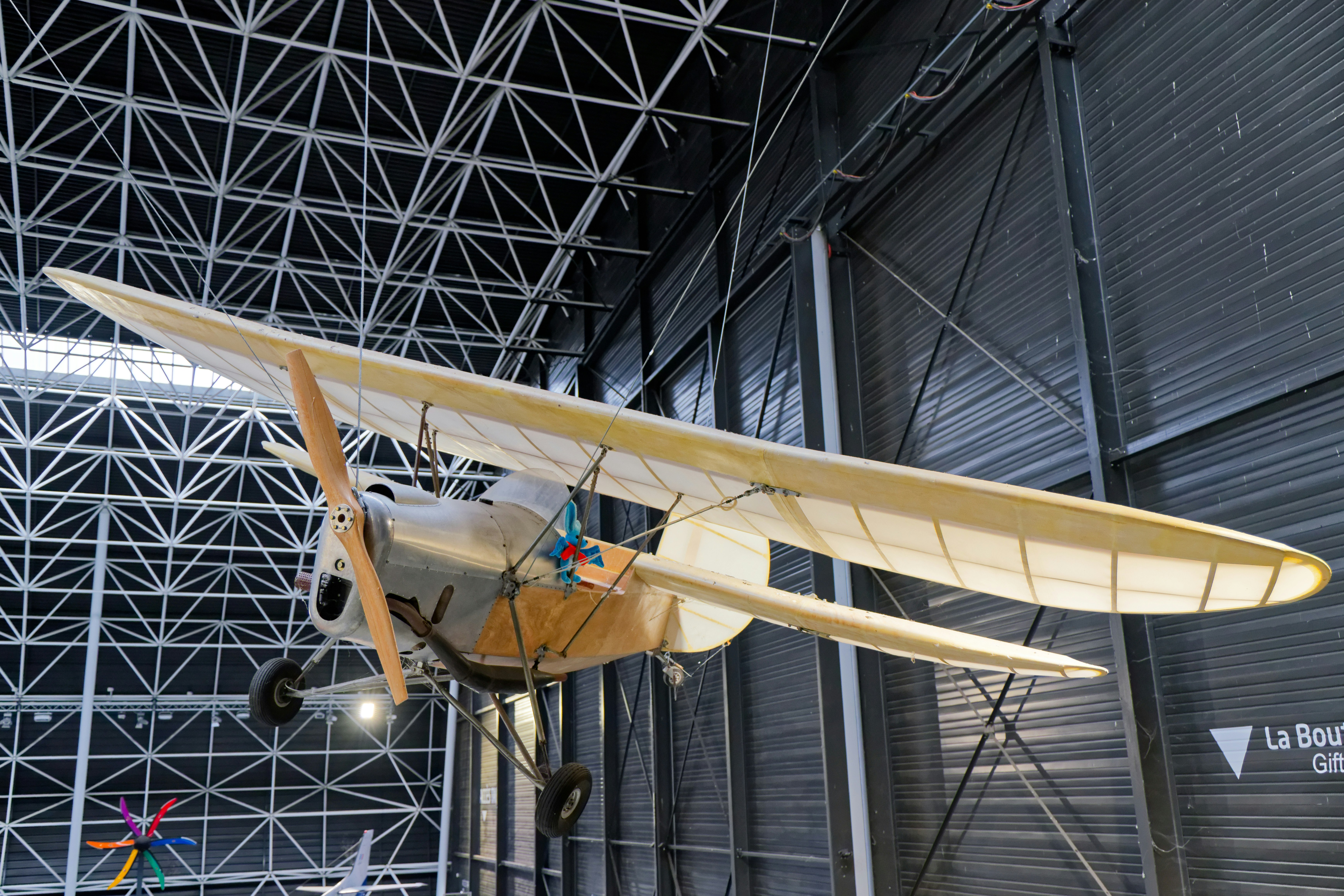 Wingspan in the Hangar: Vintage Aircraft Suspended in Light