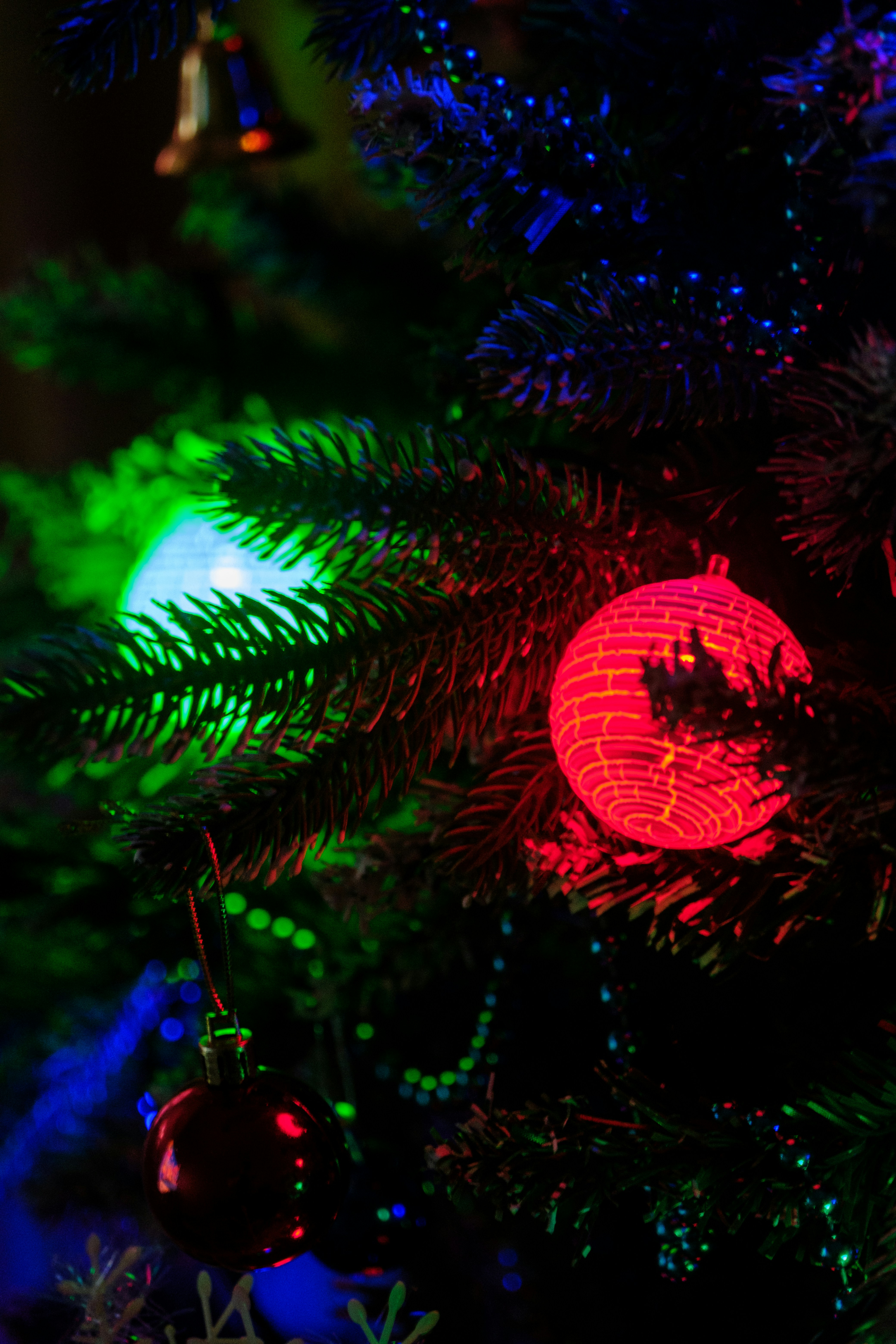 Crimson Ornament in a Neon-Glow Christmas Tree