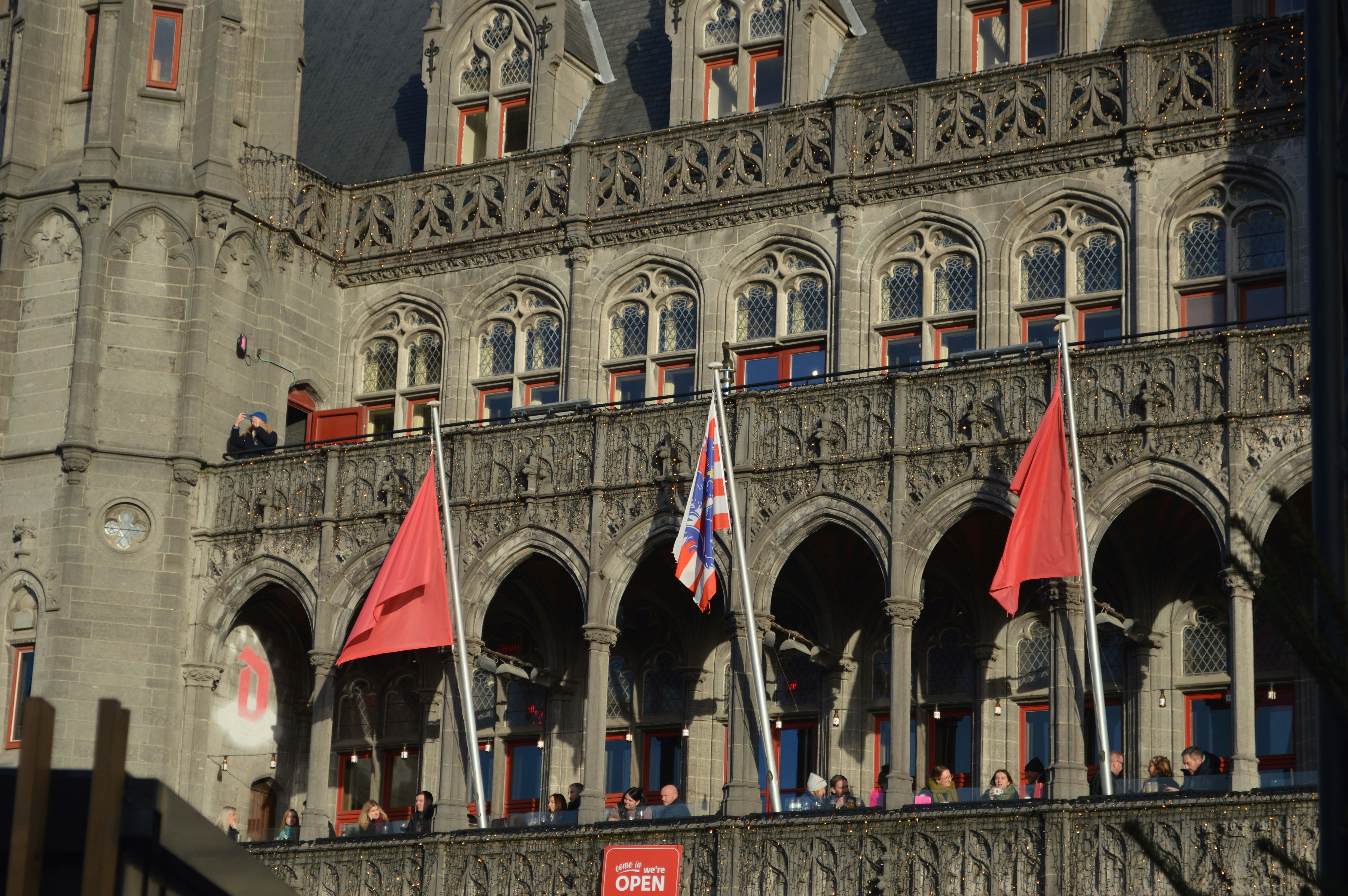 Flags and Gothic Stonework: A Moment on the Balcony