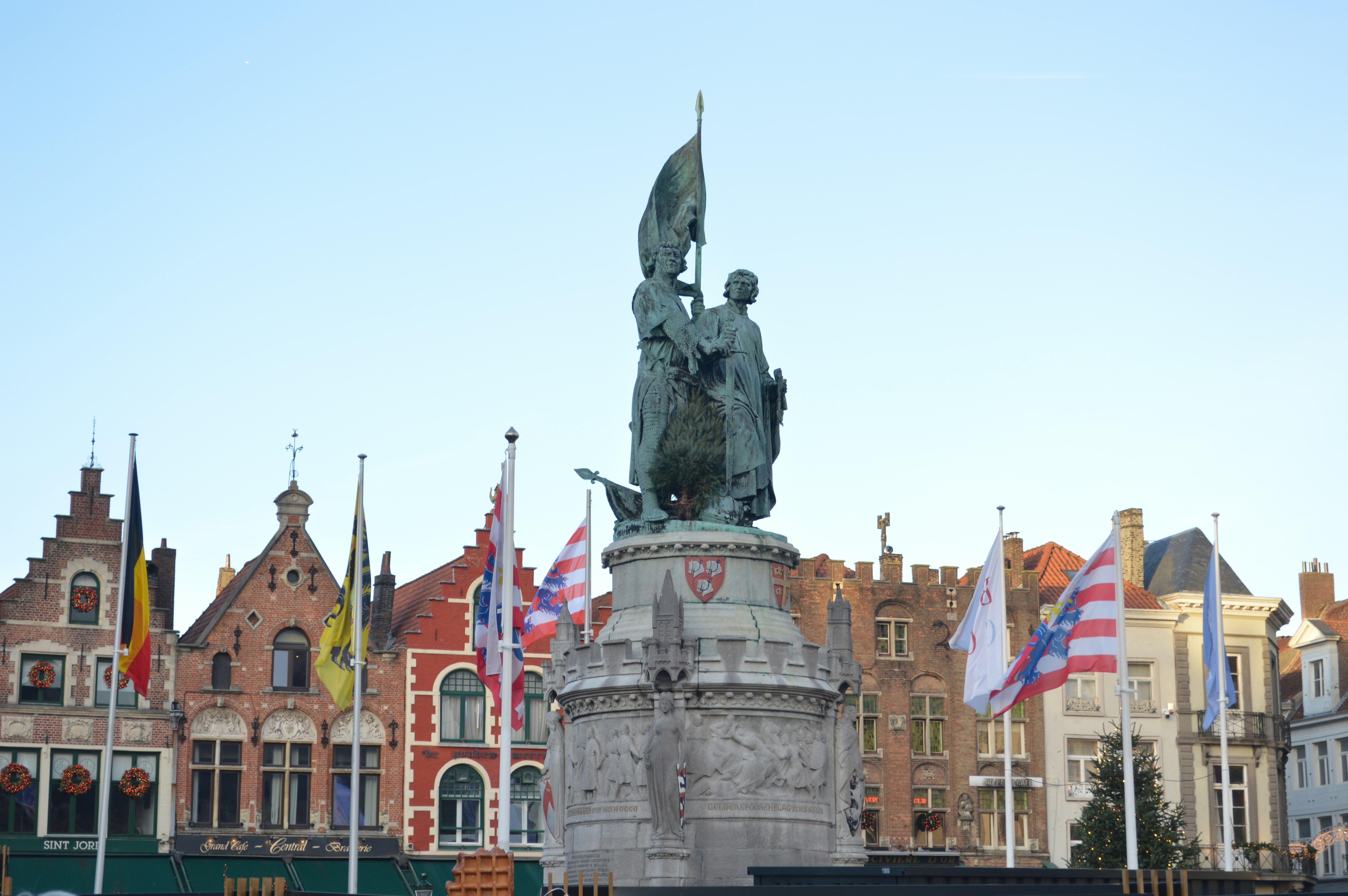 Statue and Town Hall Symmetry: A European Square in Morning Light