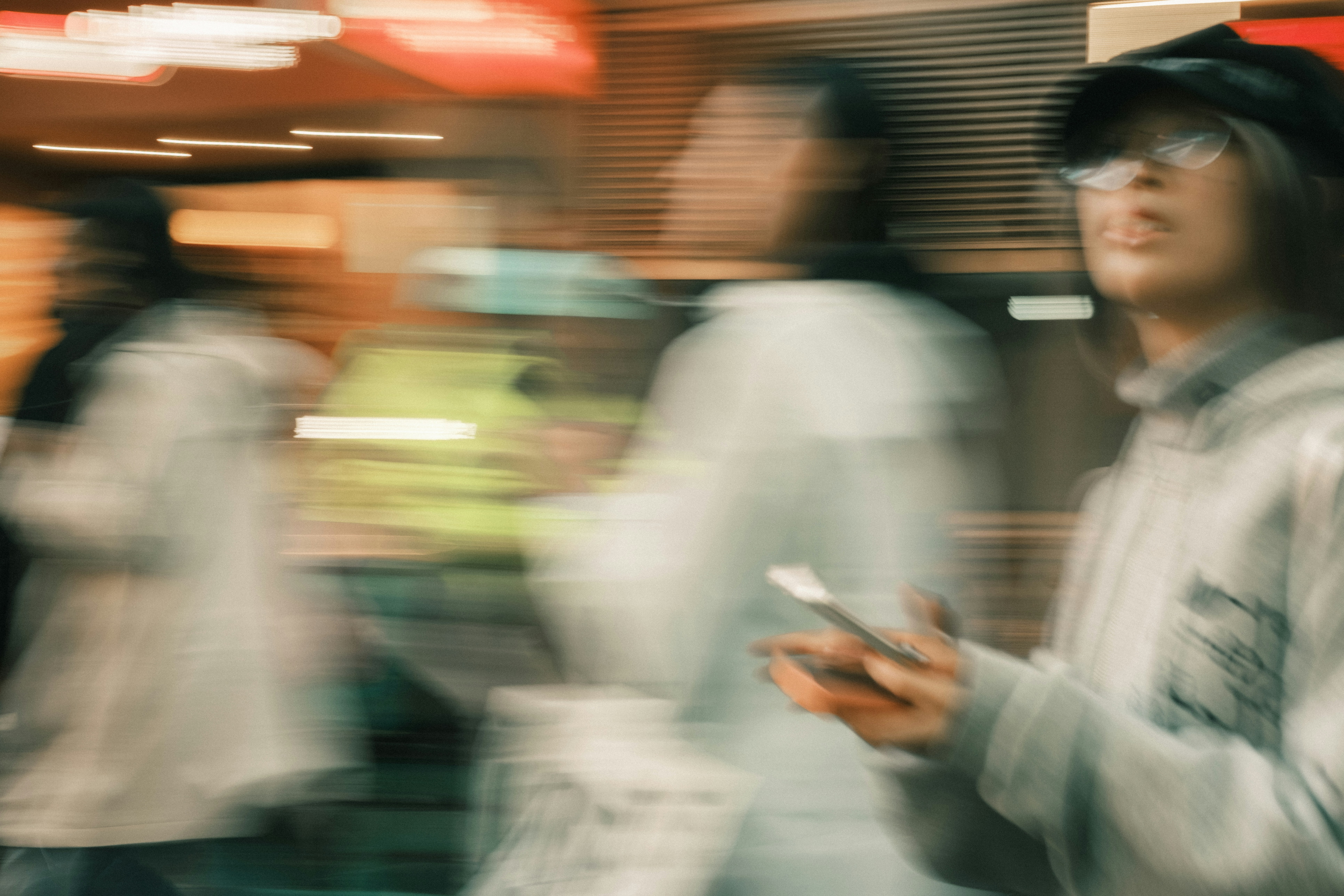 Blurred Motion in a Neon-Bathed Street Scene
