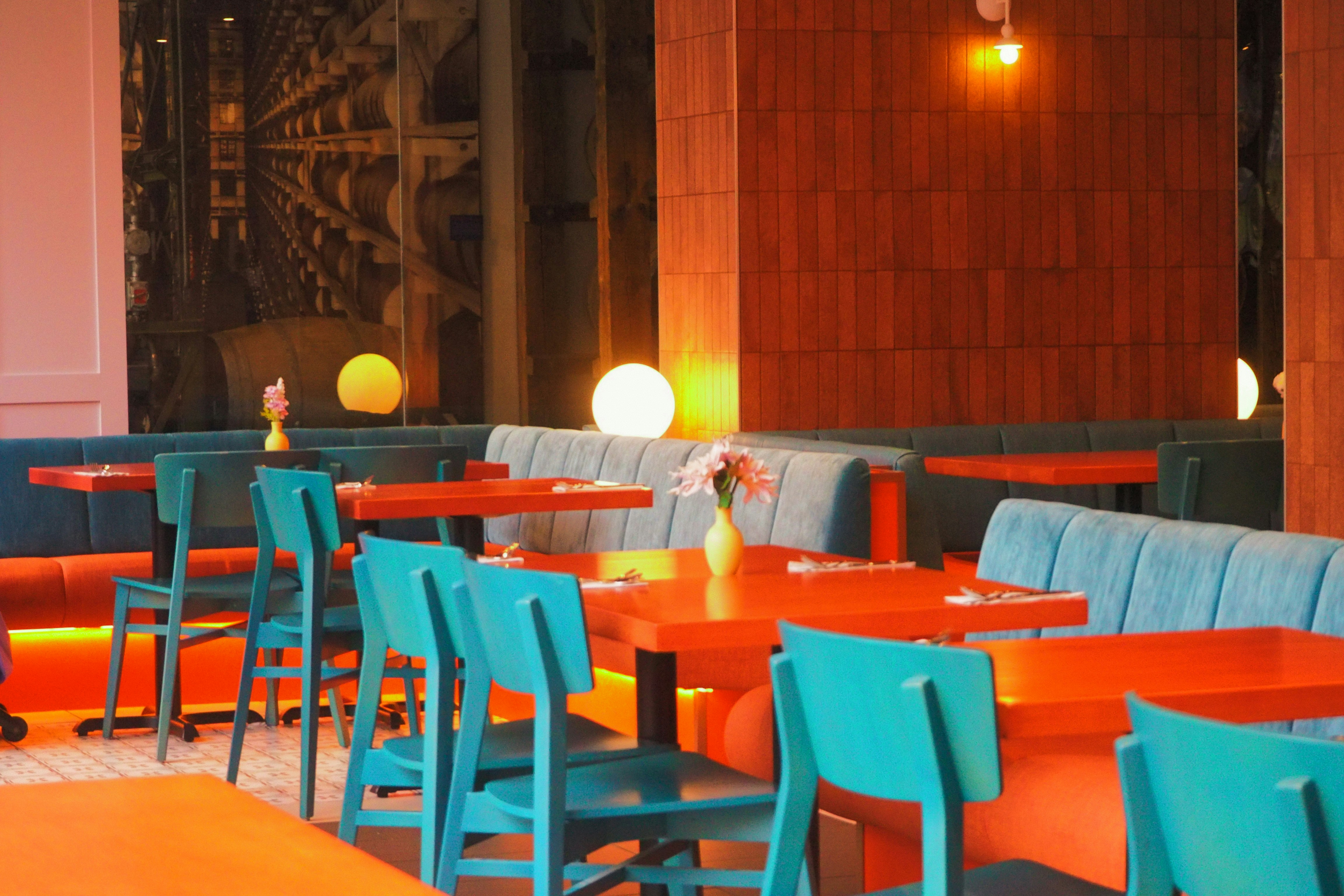 Teal Chairs and Neon Glow in a Cozy Urban Café