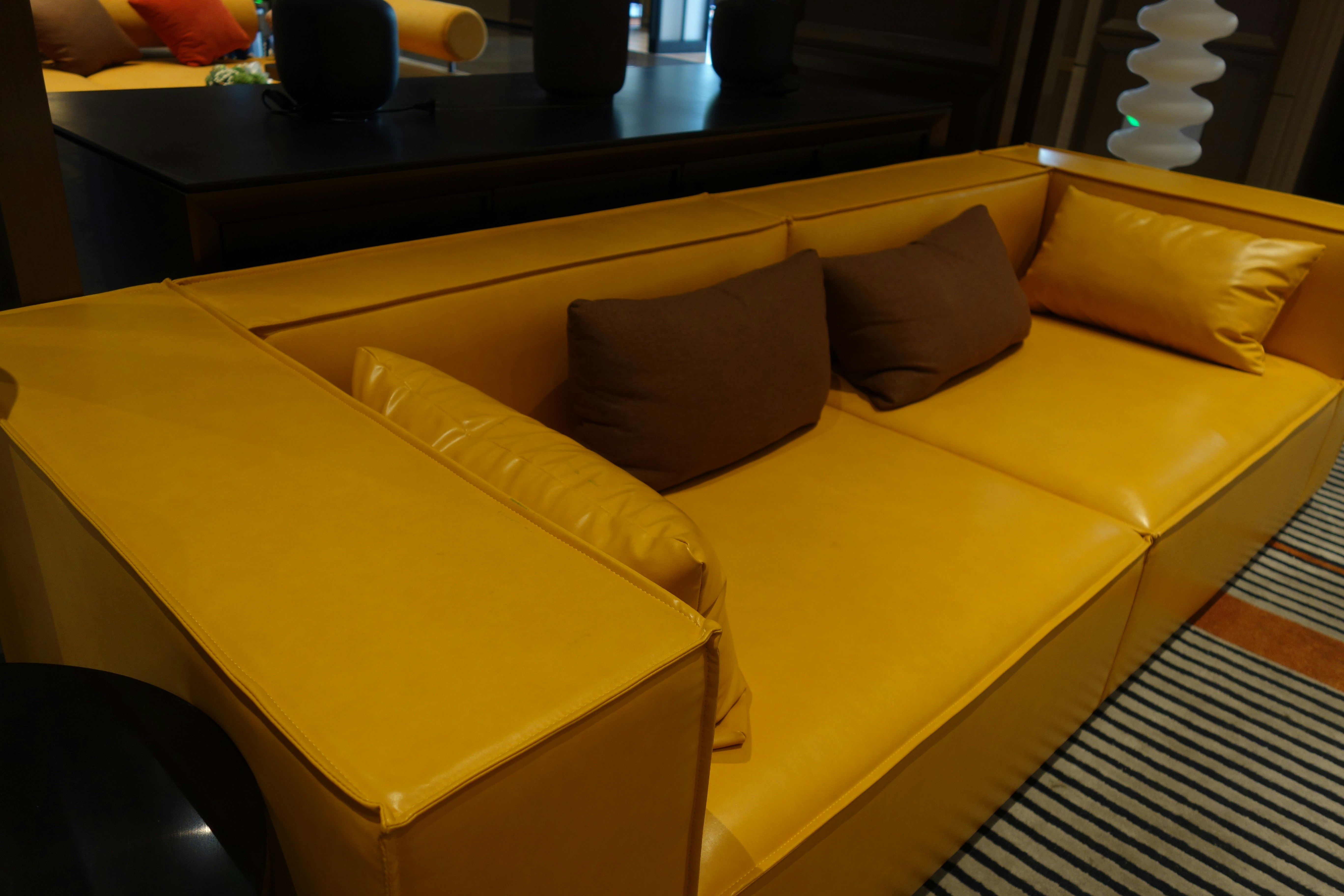 Mid-Century Comfort: Sunlit Orange Lounge with Brown Cushions