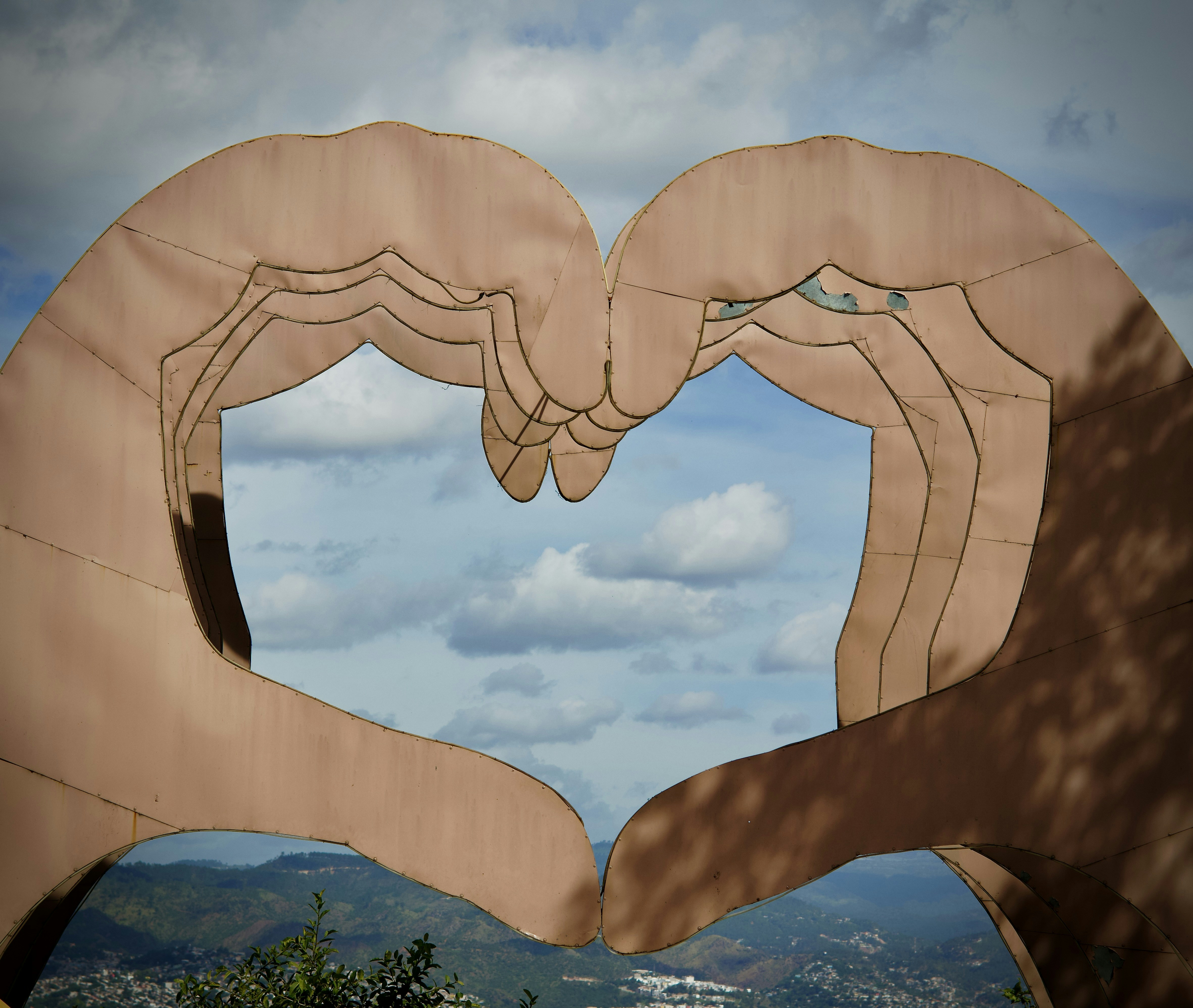Heart Scaffold: Stone Arms Framing Sky