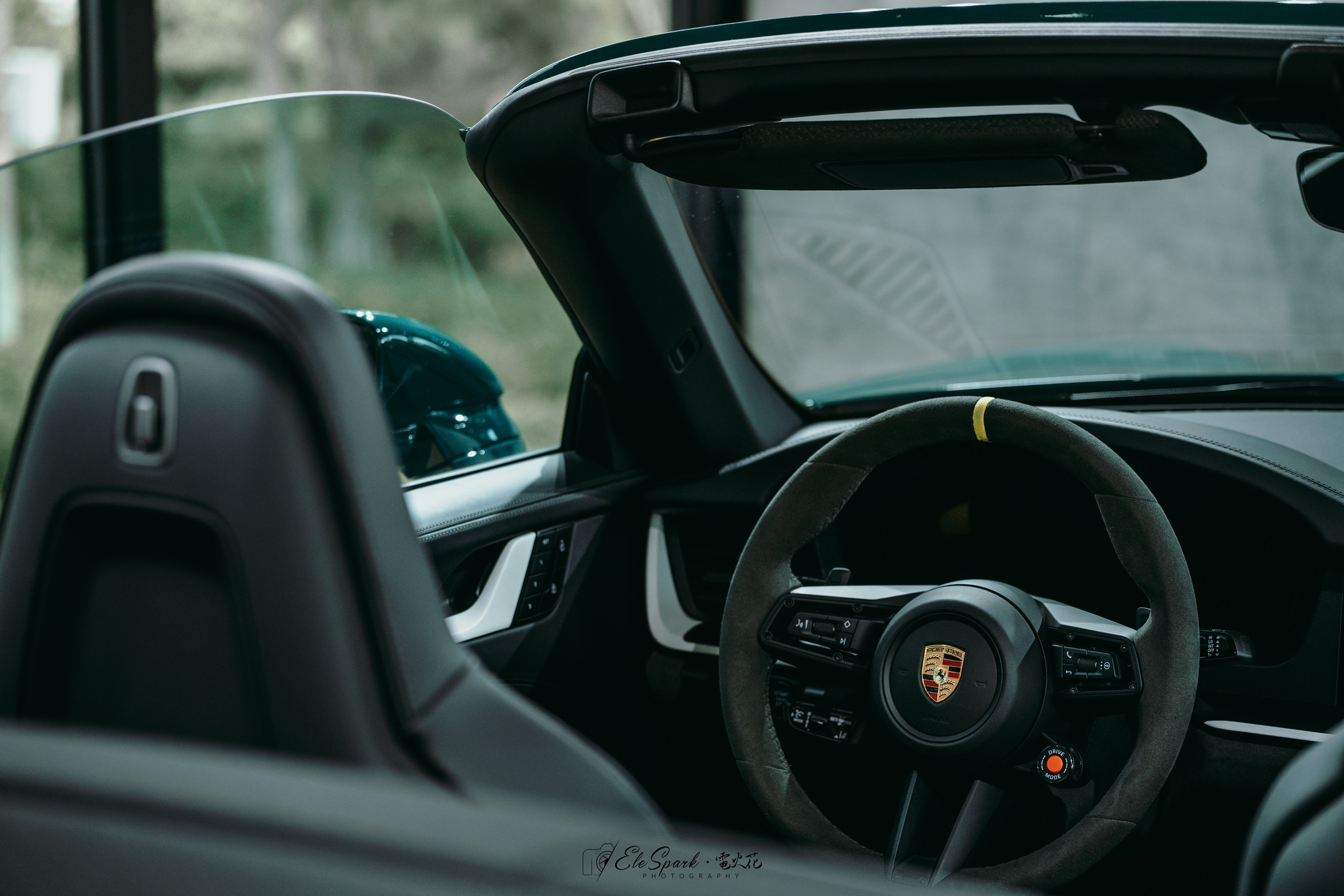 Interior view of a green porsche convertible with open door