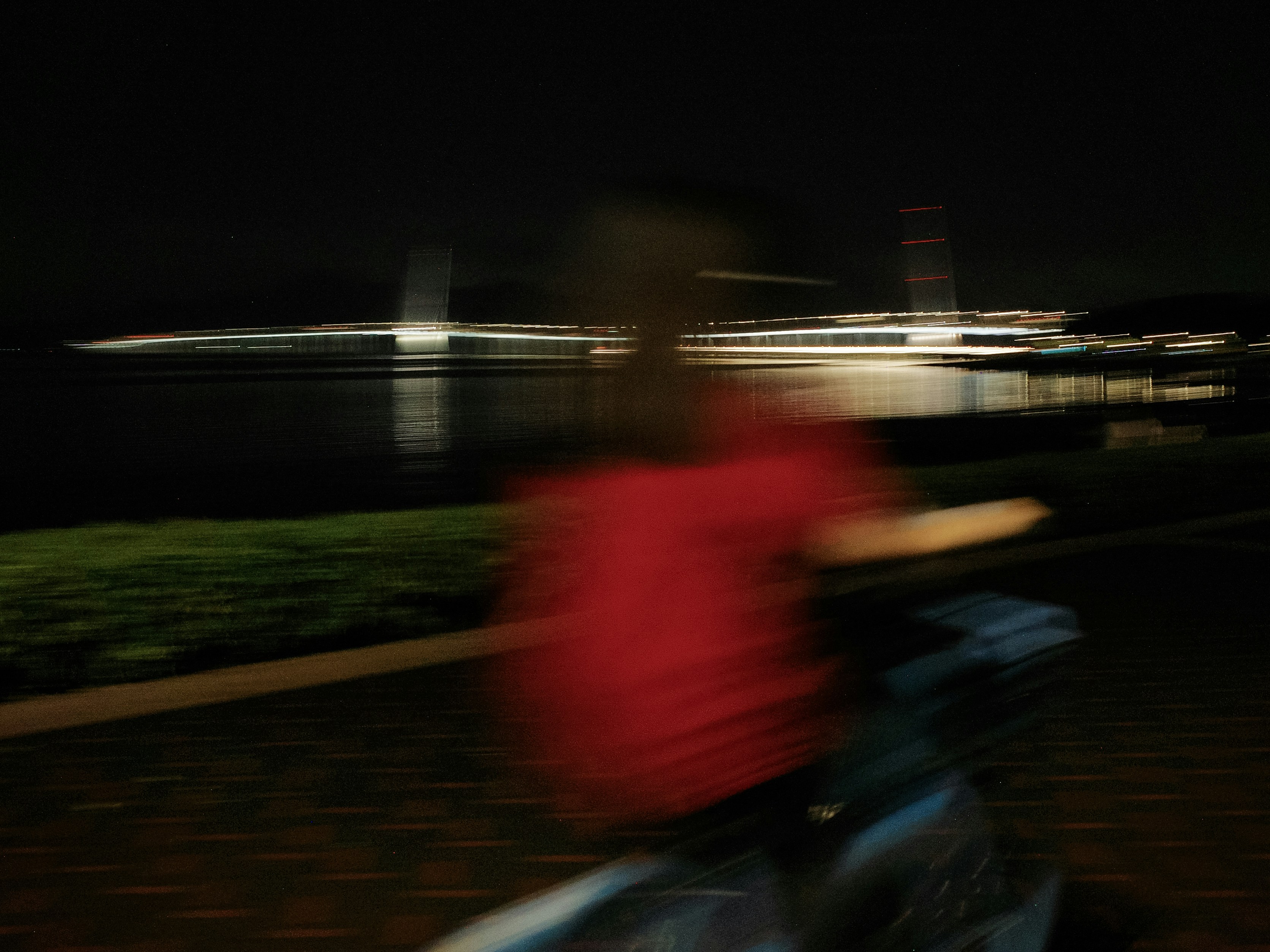 Night Traffic in Motion: A Blurred Bokeh of Lights and a Red Shirt