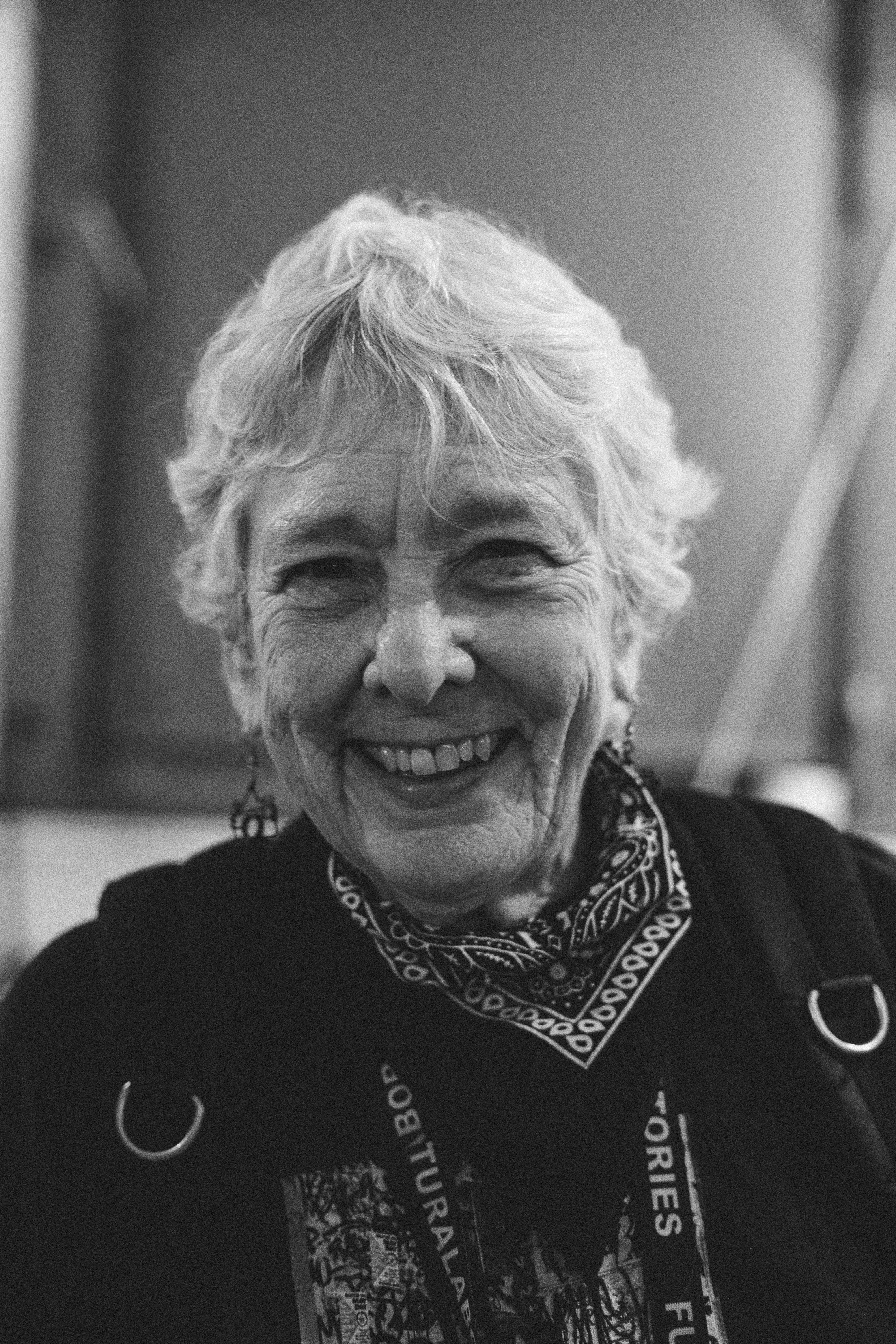Smiling Portrait of Experience: A Weathered Grin in Mono