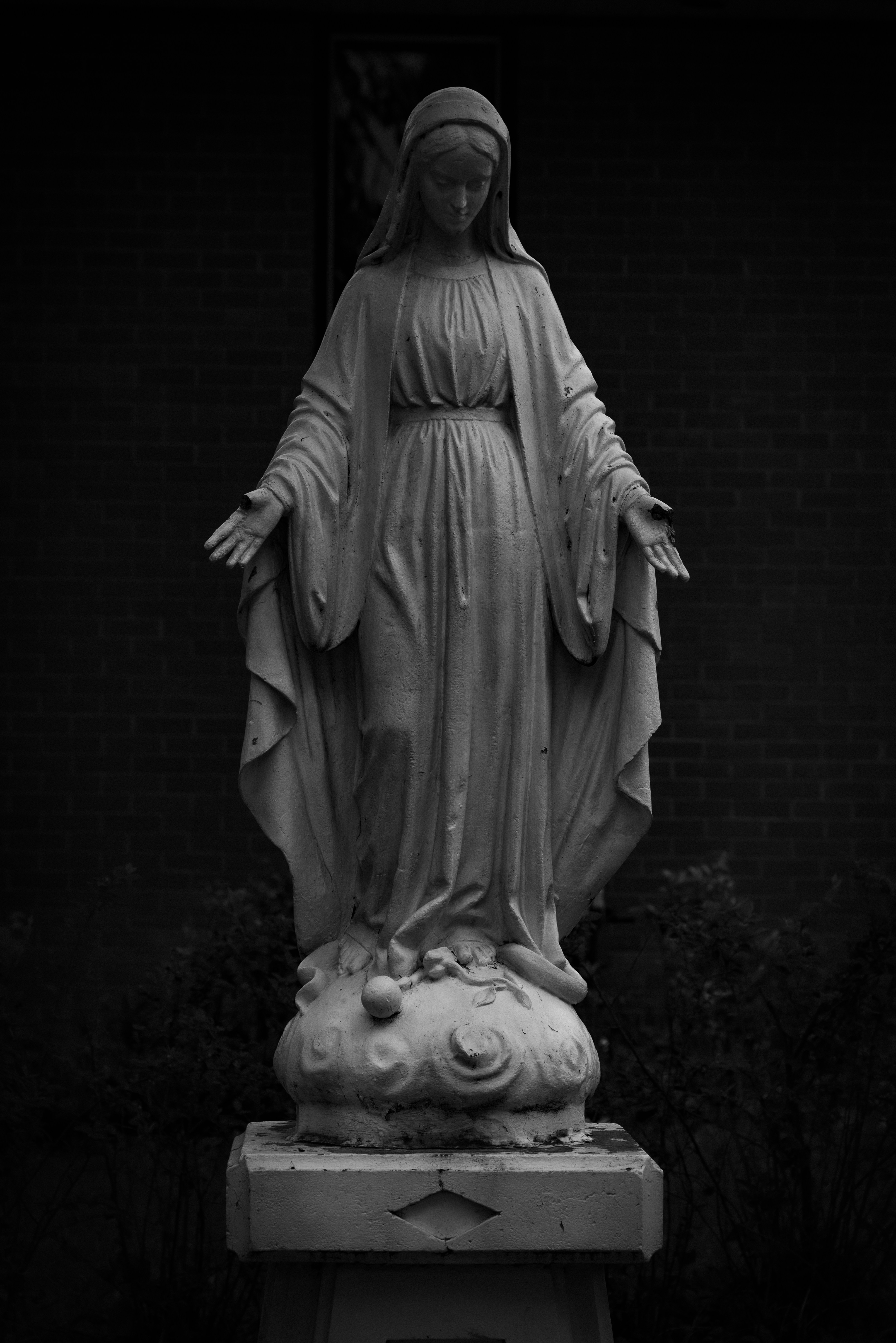 The Silent Sentinel: A Monumental Madonna in Moonlit Quiet