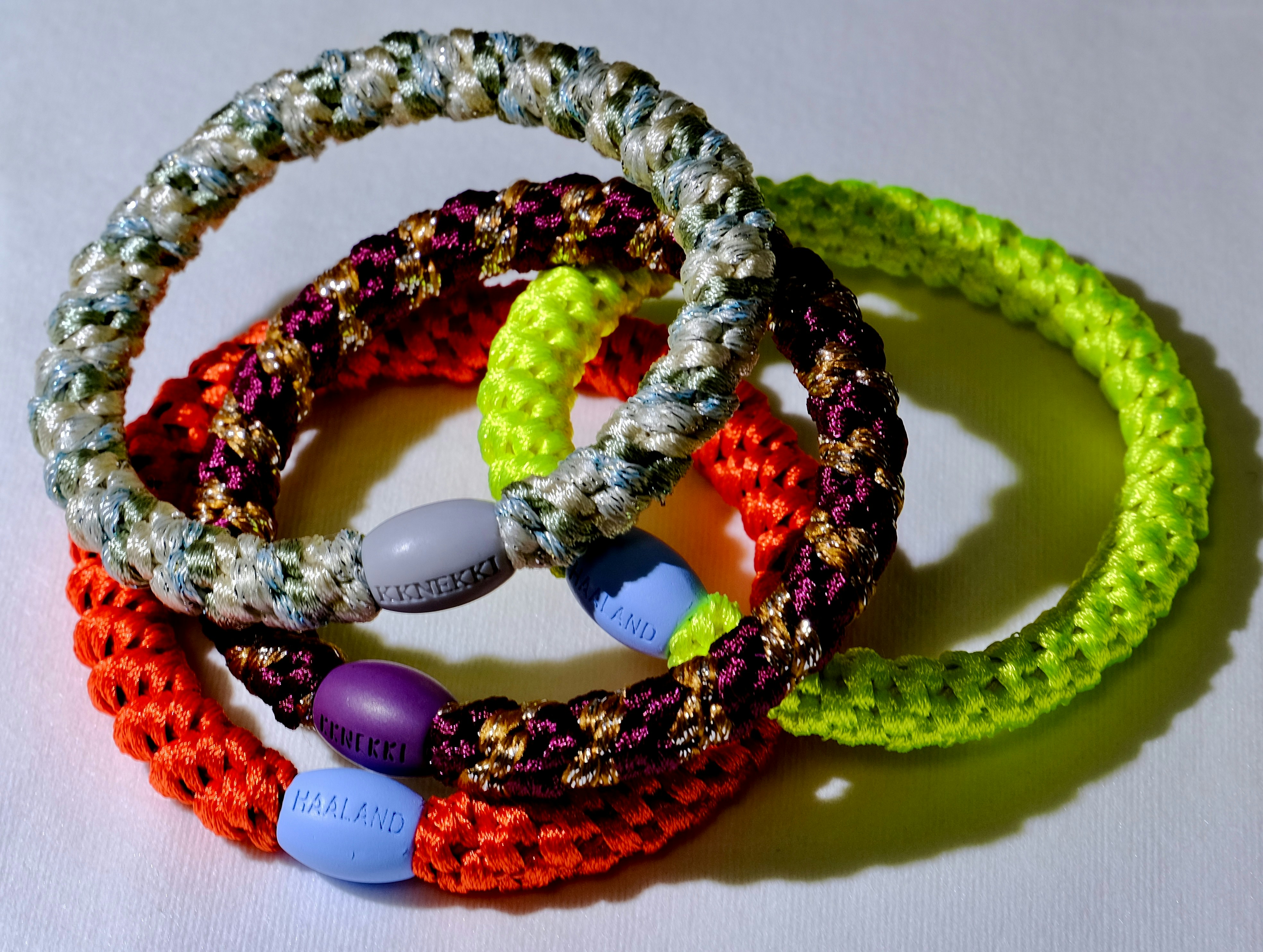Vivid Braided Bracelets: Neon, Coral, and Pastel Beads in Close Knit Display