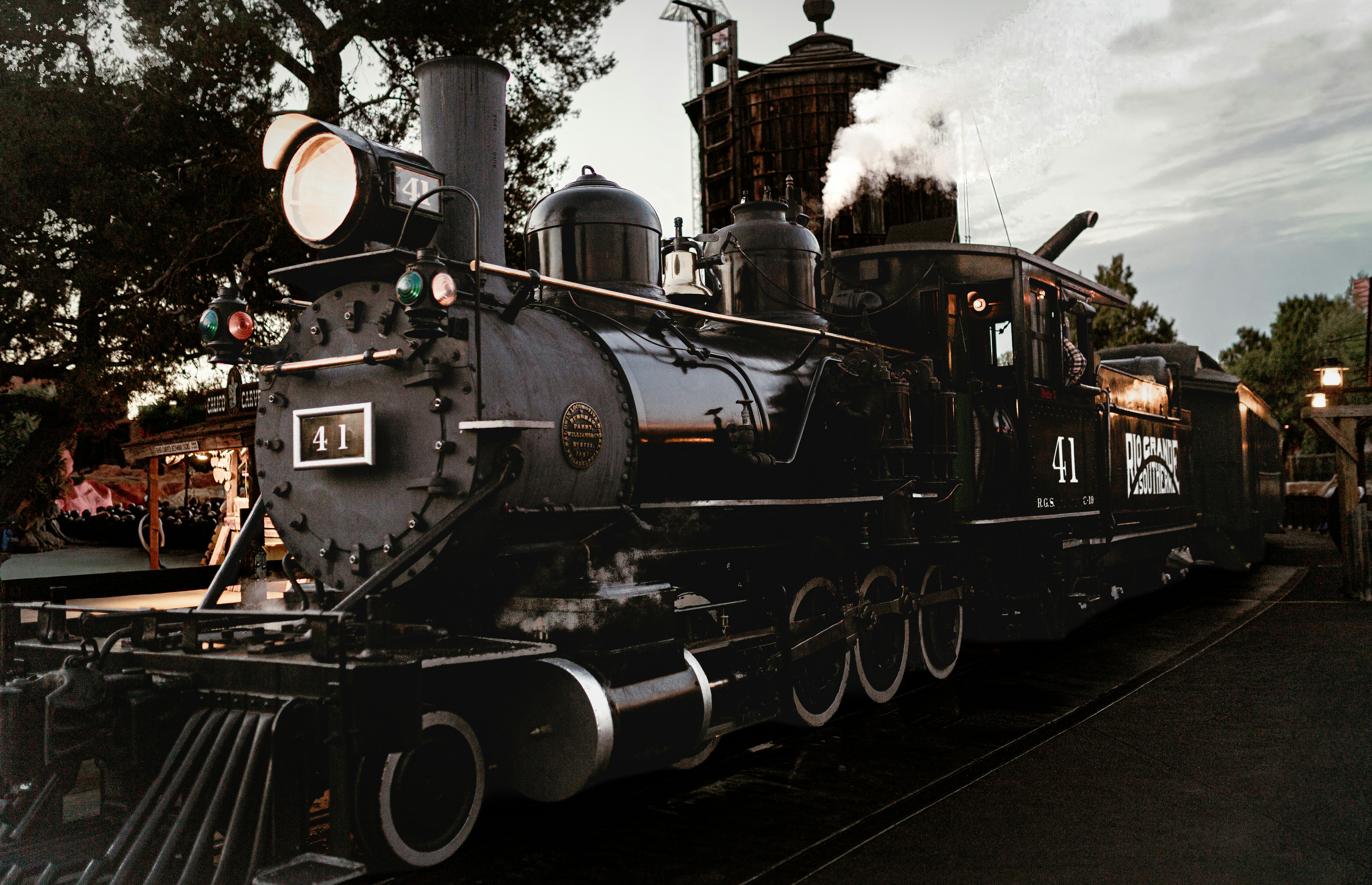 Metallic Behemoth on Rails: A Steam Engine Idle at Twilight