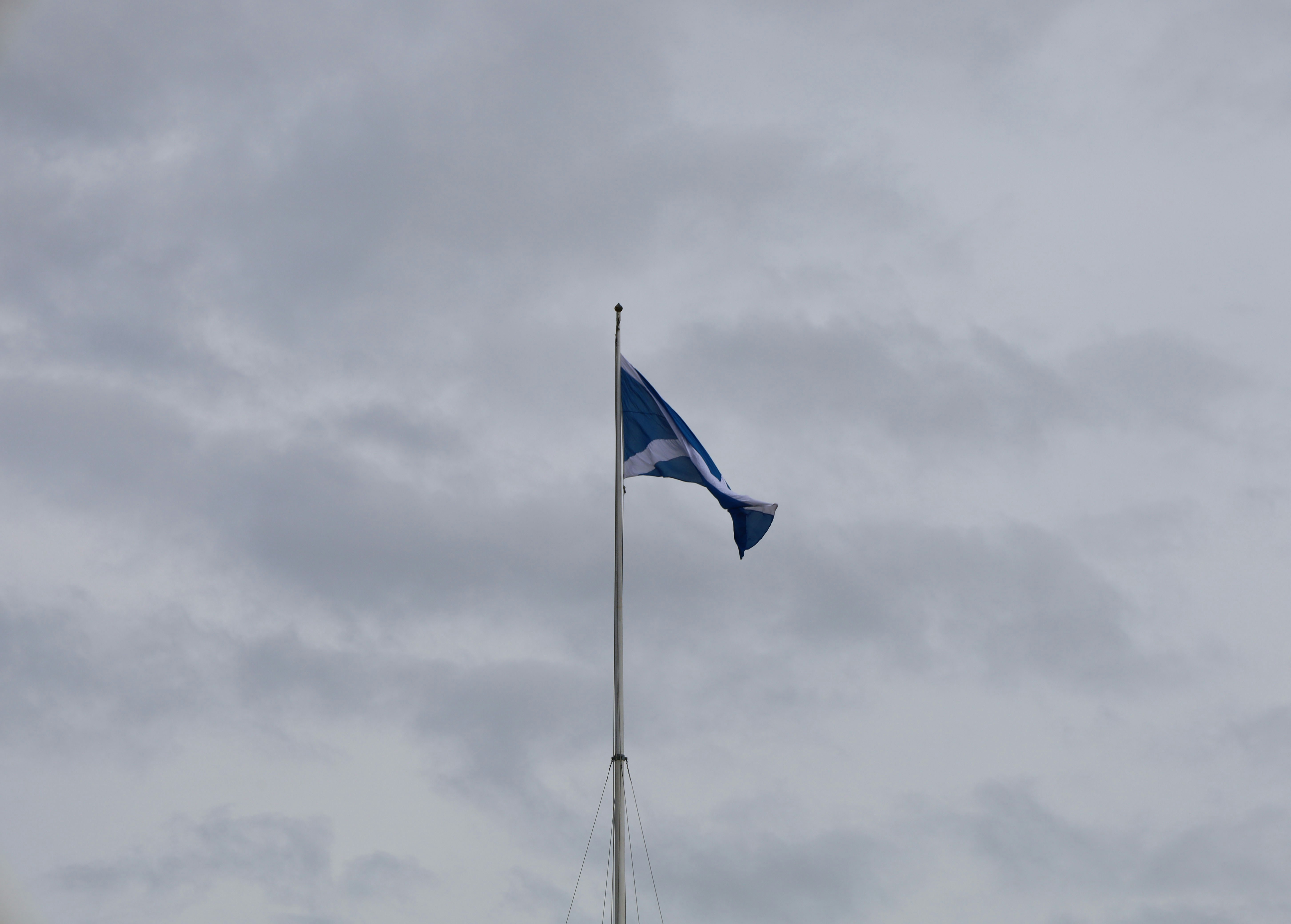 Pole Above the Clouds: A Lone Flag at Height
