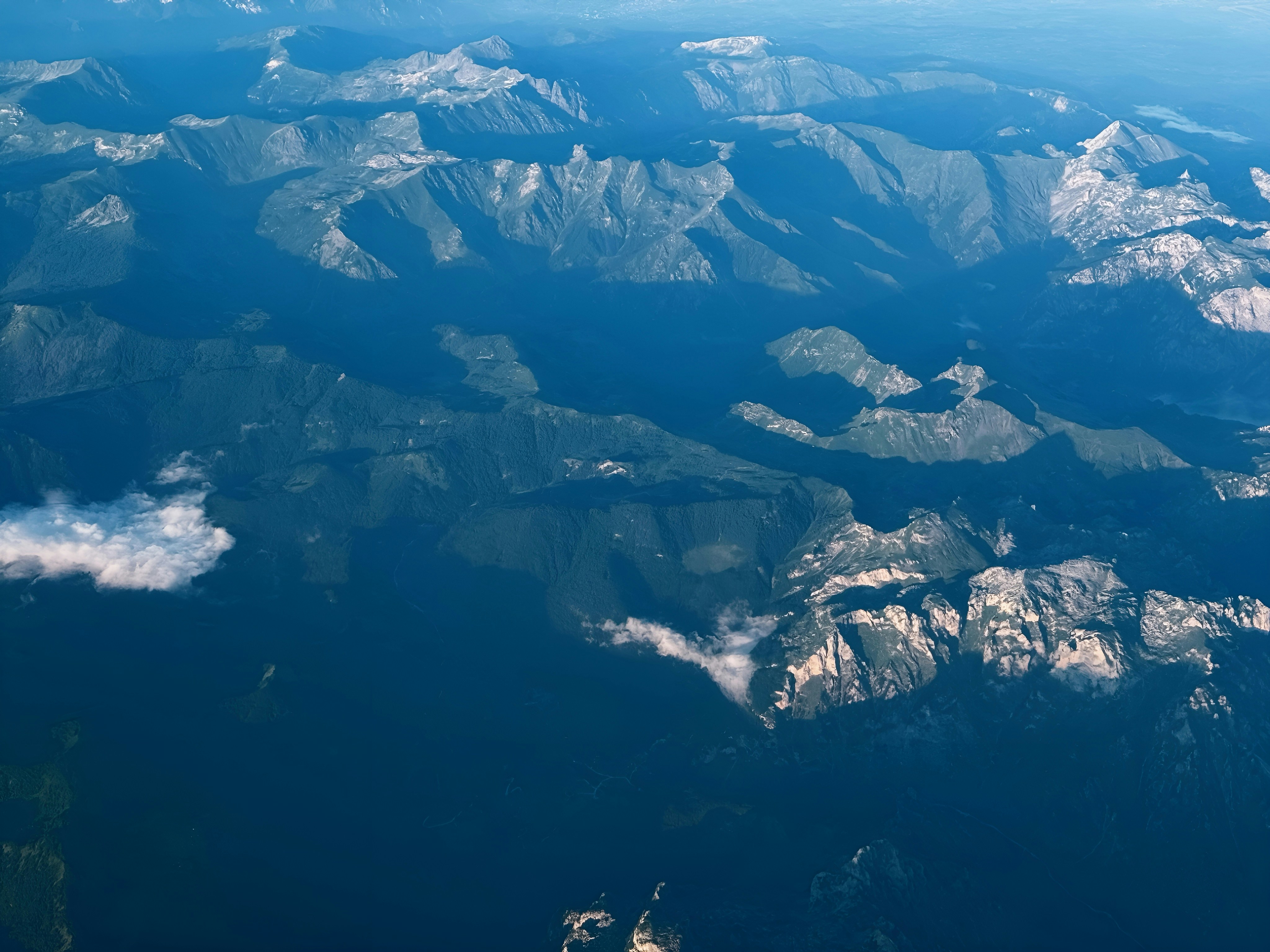 Ridge Echoes: Aerial Portrait of Snow-Trimmed Peaks