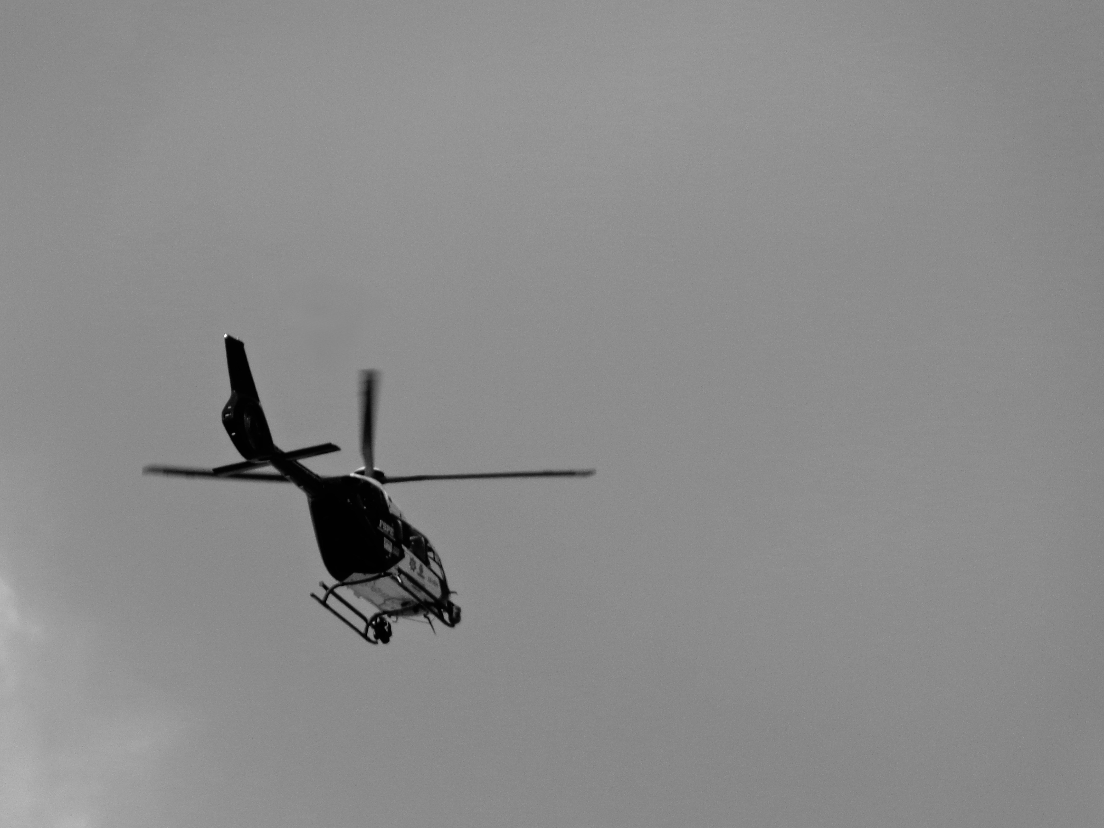 Shadowed Helix: A lone helicopter in monochrome ascent