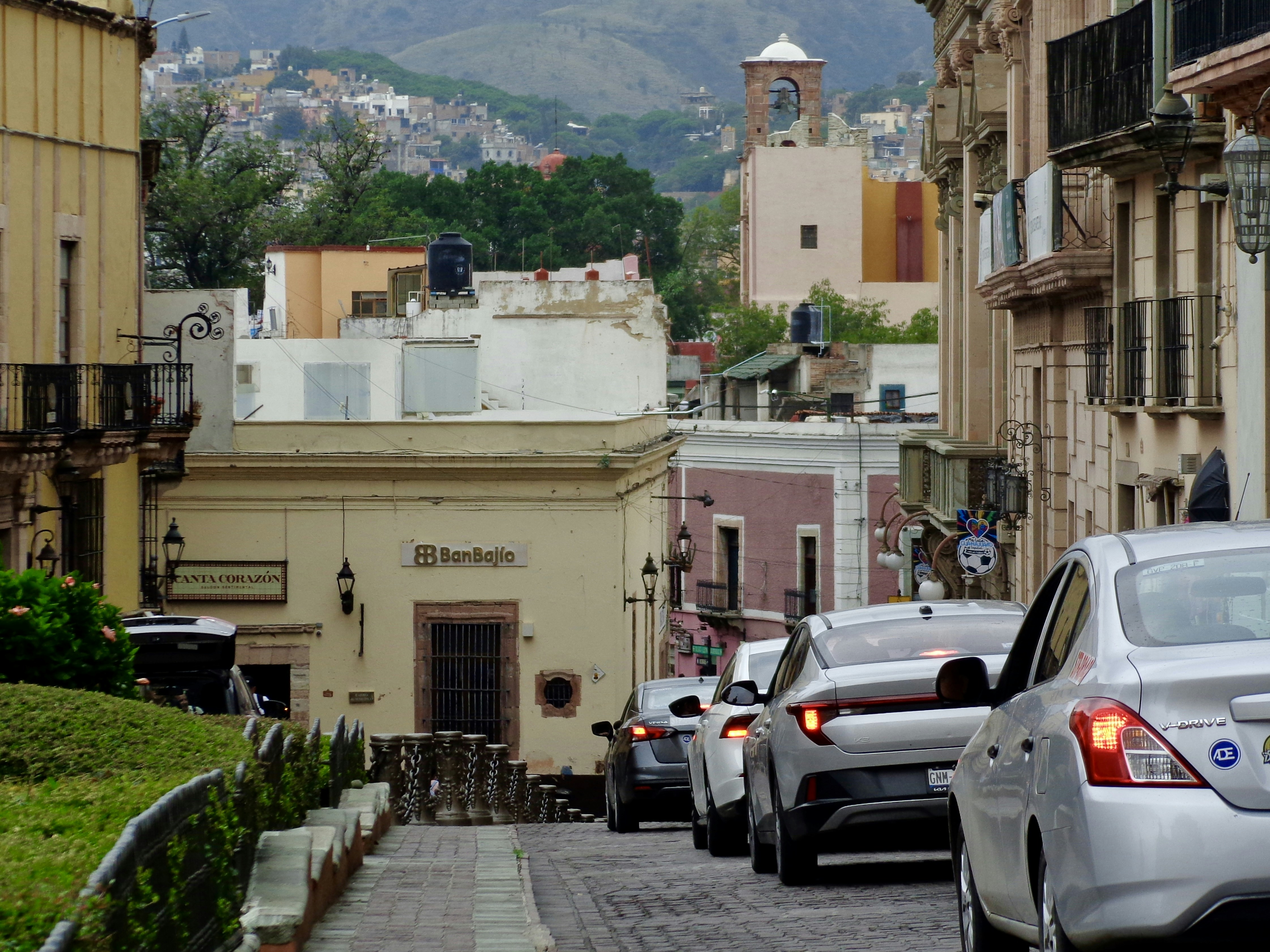 Cobbled Street Confluence: Cars, Colors, and Civilian Pace