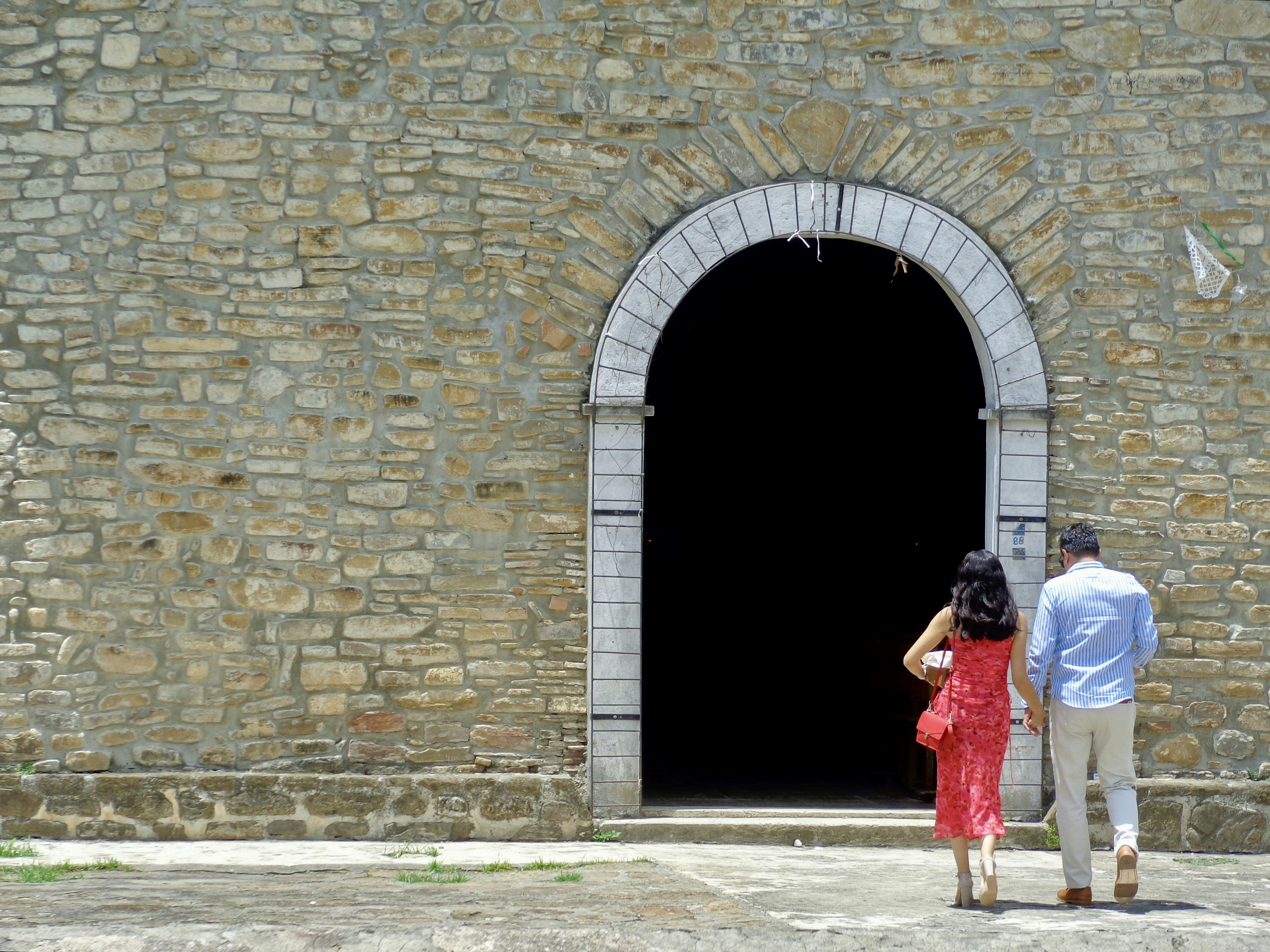 Couple in Red by the Stone Archway
